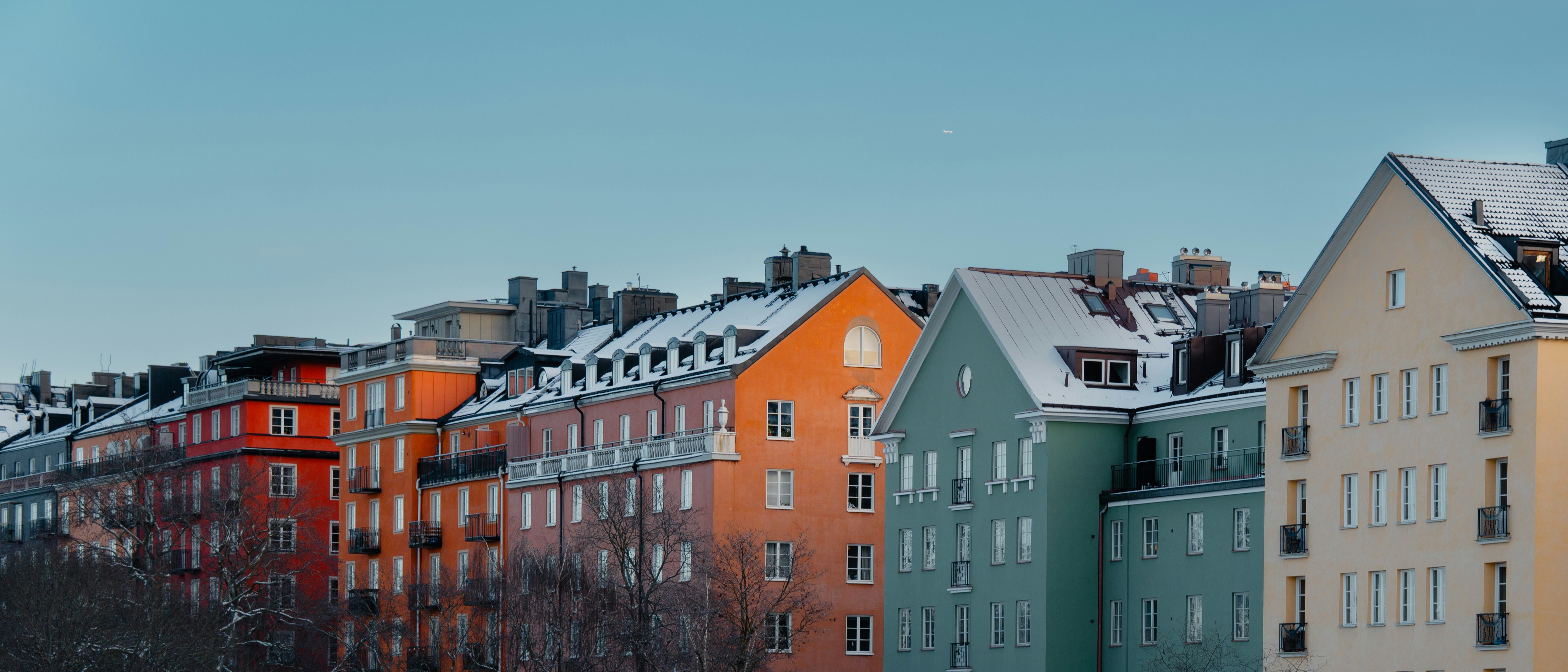 Row of Painted Townhouses Turning a Street into a Rainbow