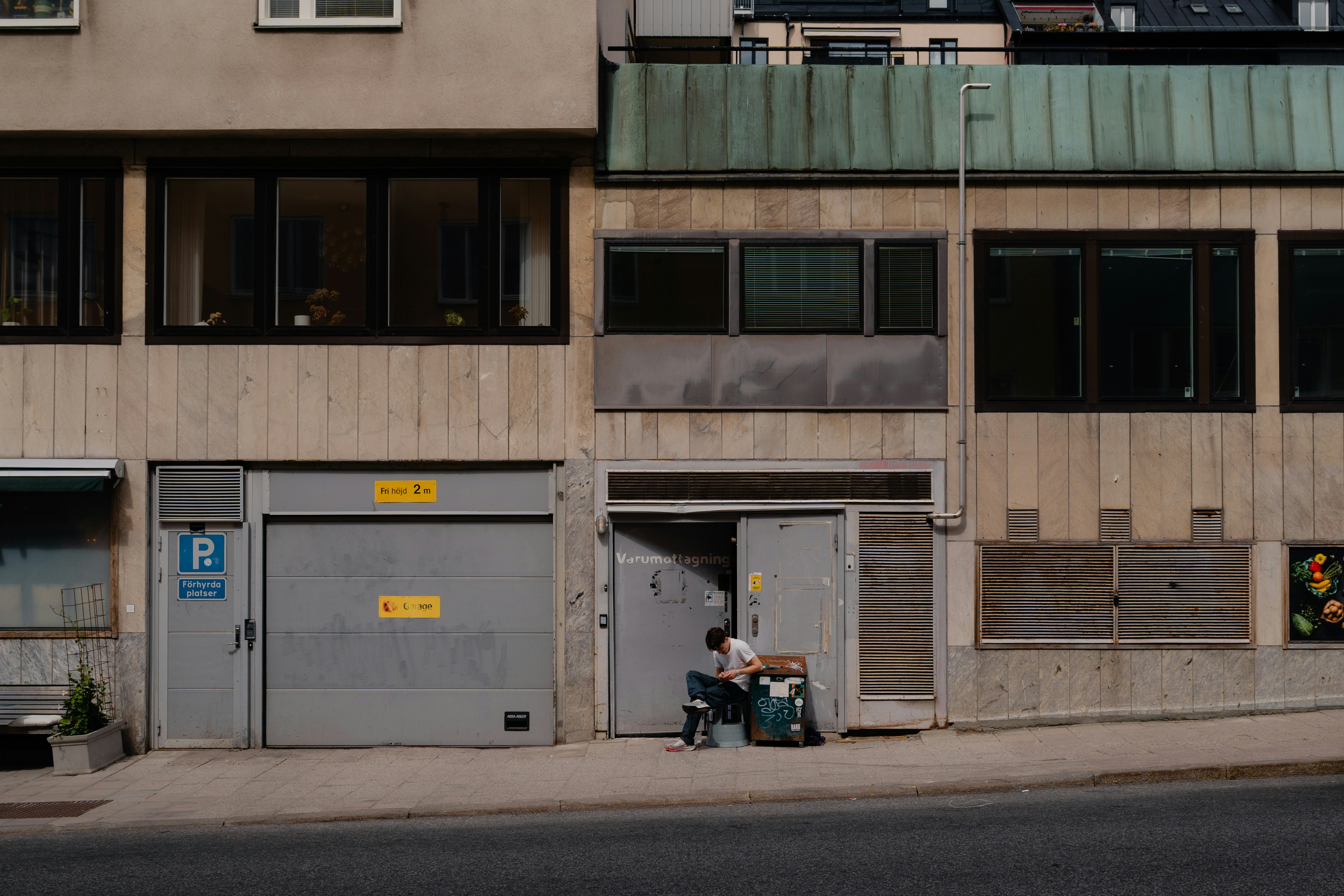 Urban Quiet: A Man and Cart by the Closed Garage