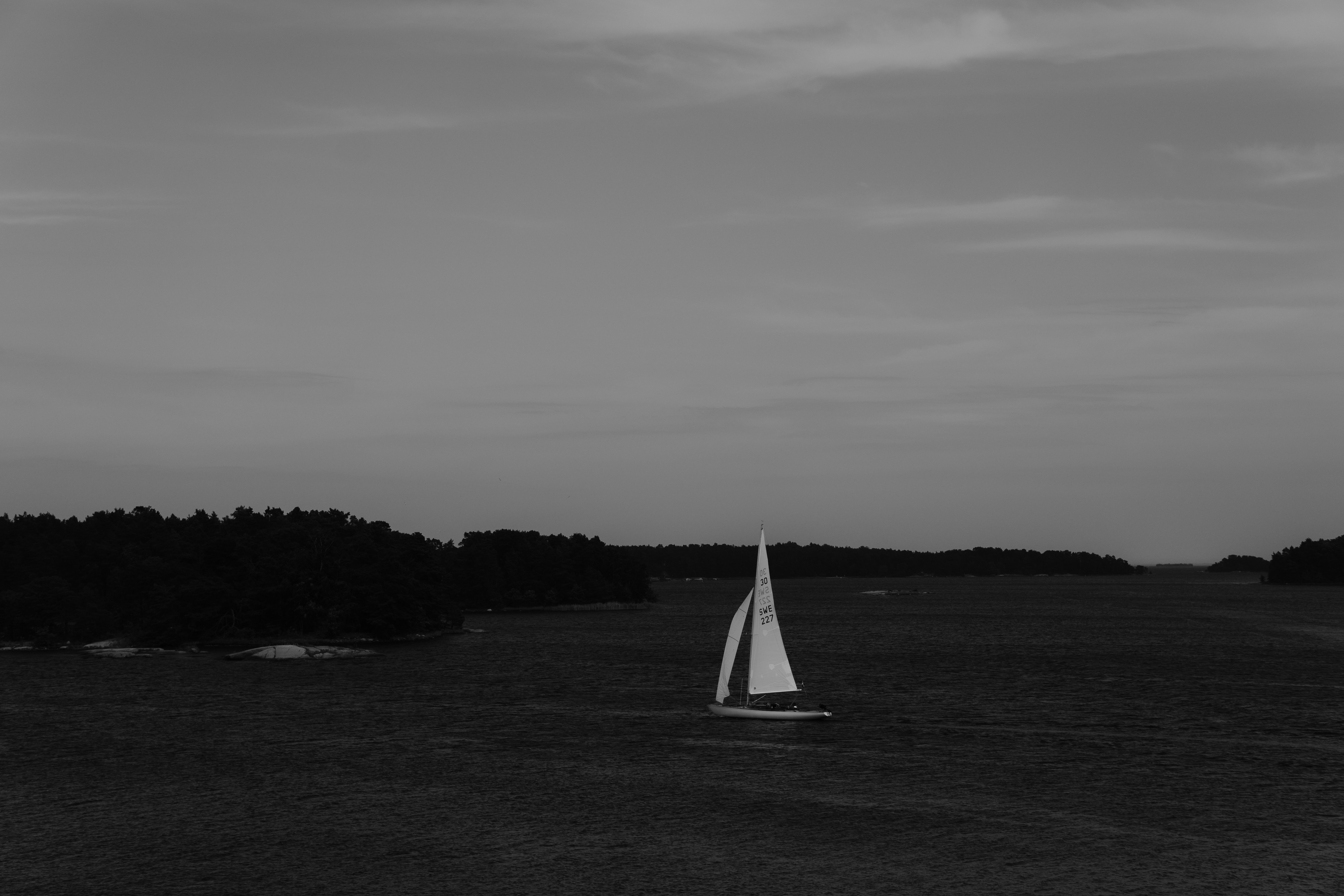 Sailboat Quiet on a Broad Channel