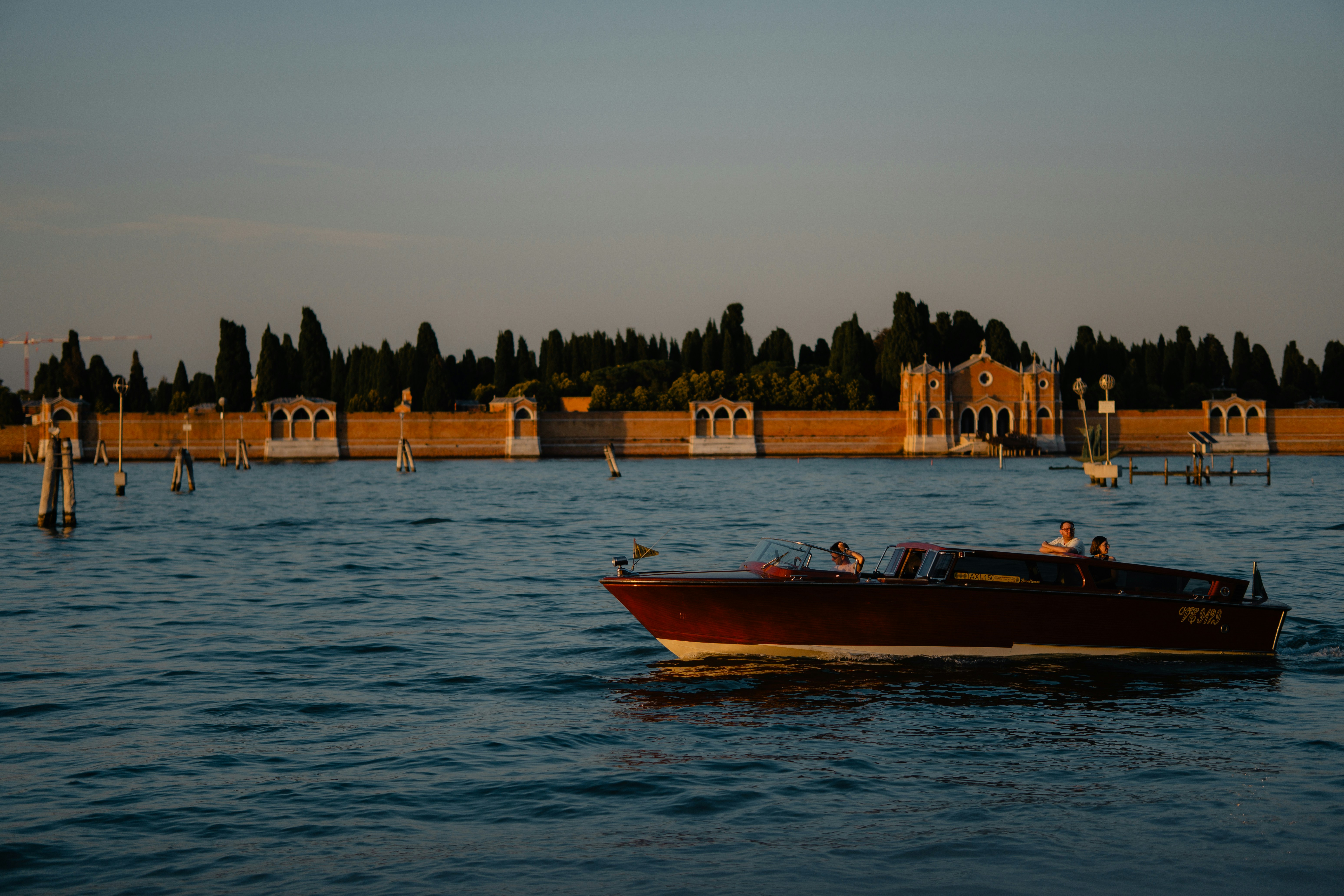 Red Boat Crossing the Venetian-Style Wake