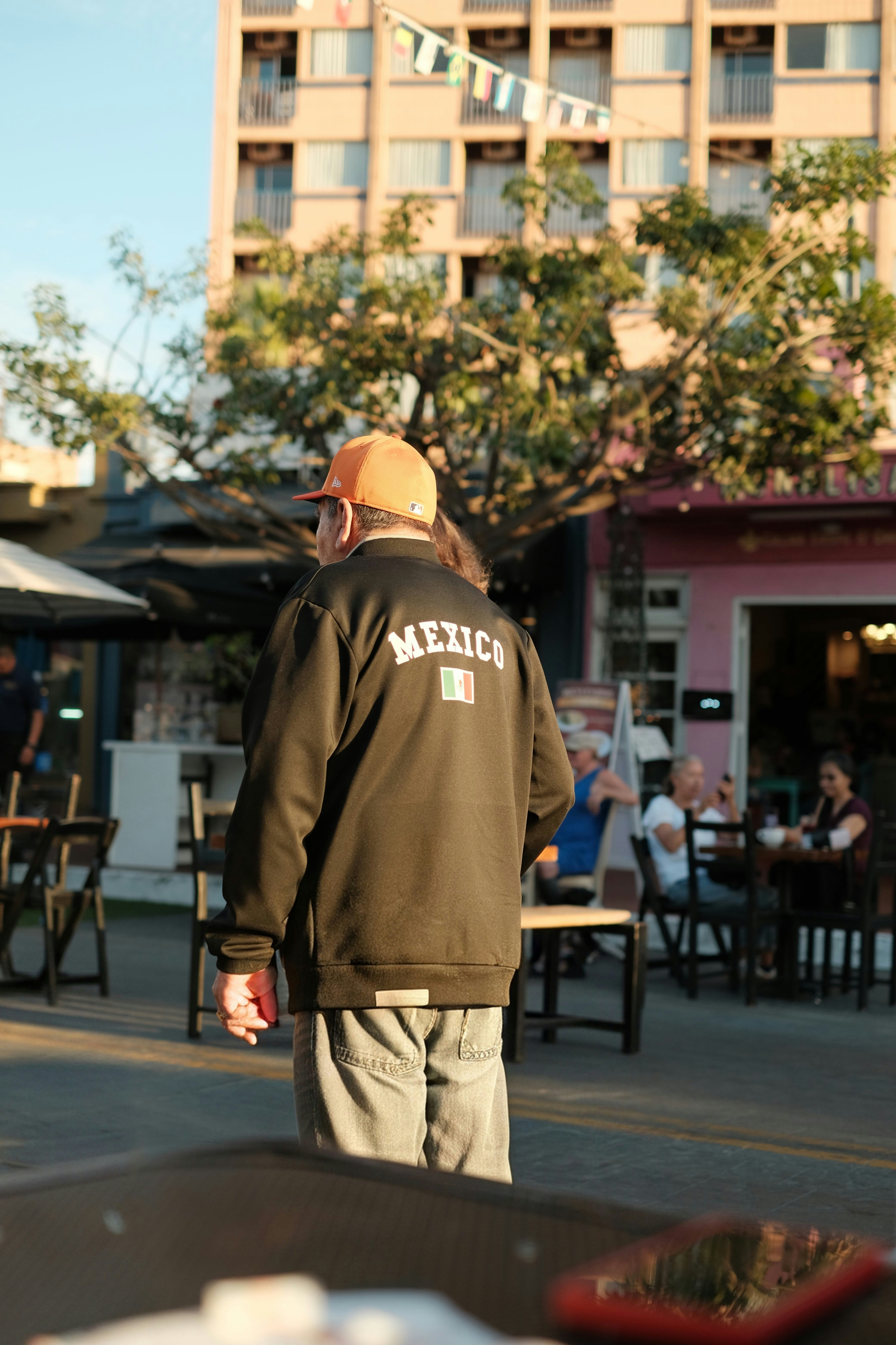 Backlit in the Plaza: A Mexican Jacket Stops for a Moment