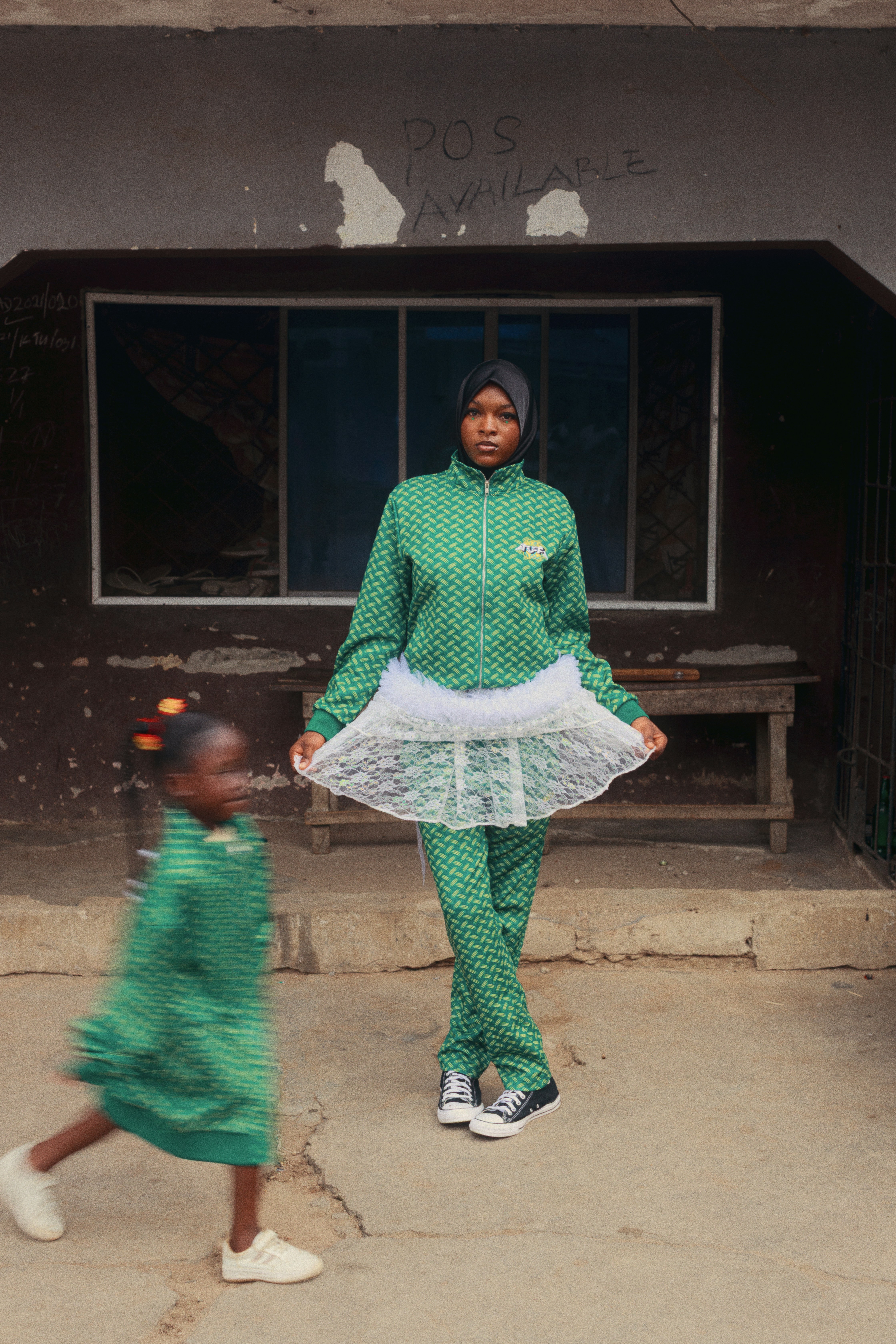 Green tracksuit Grace: The Silent Pose in a Sunlit Courtyard