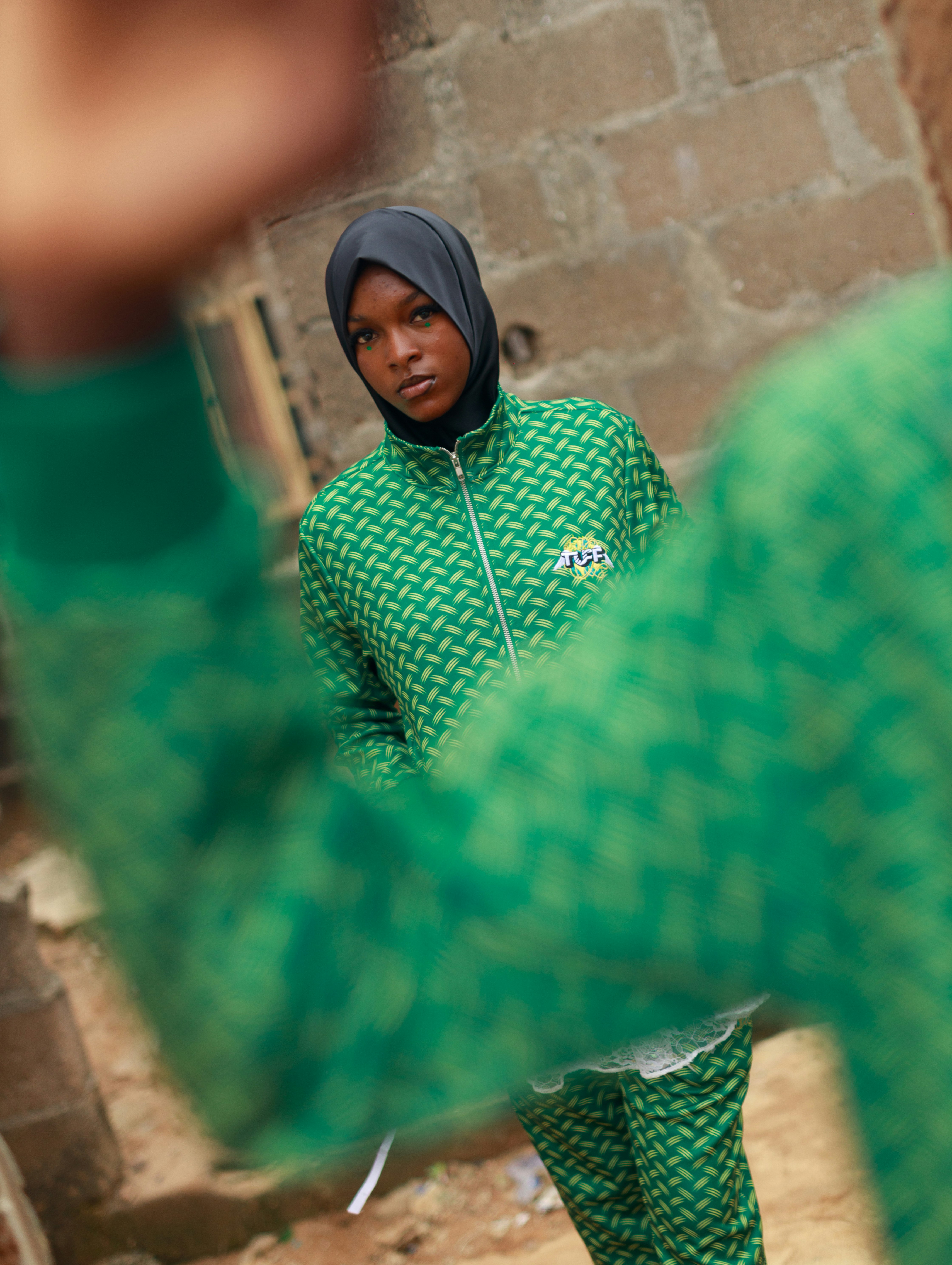 Green Tracksuit Gazing Through the Frame