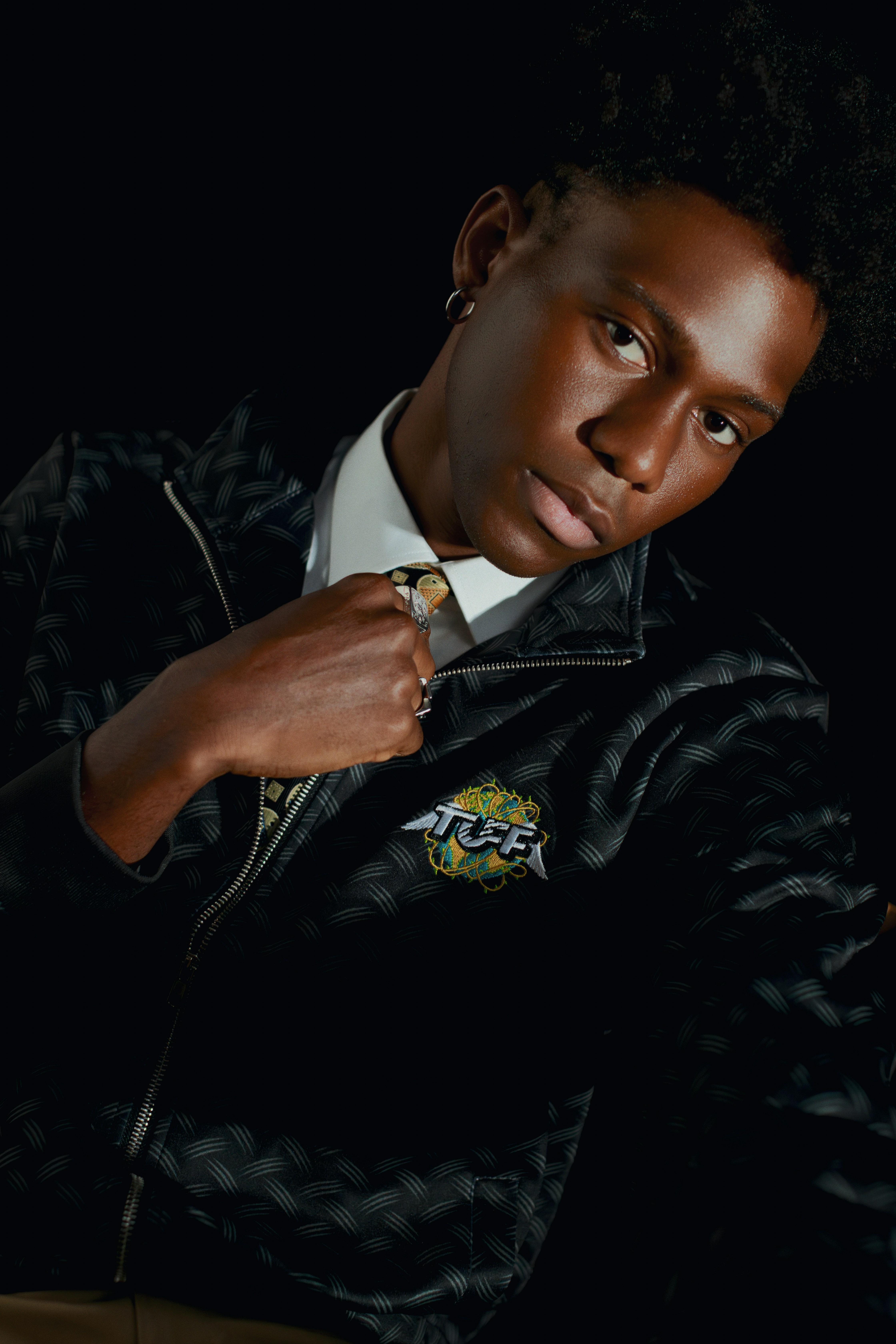 Midnight Confidence: A Portrait with a Regal Tie and Textured Jacket