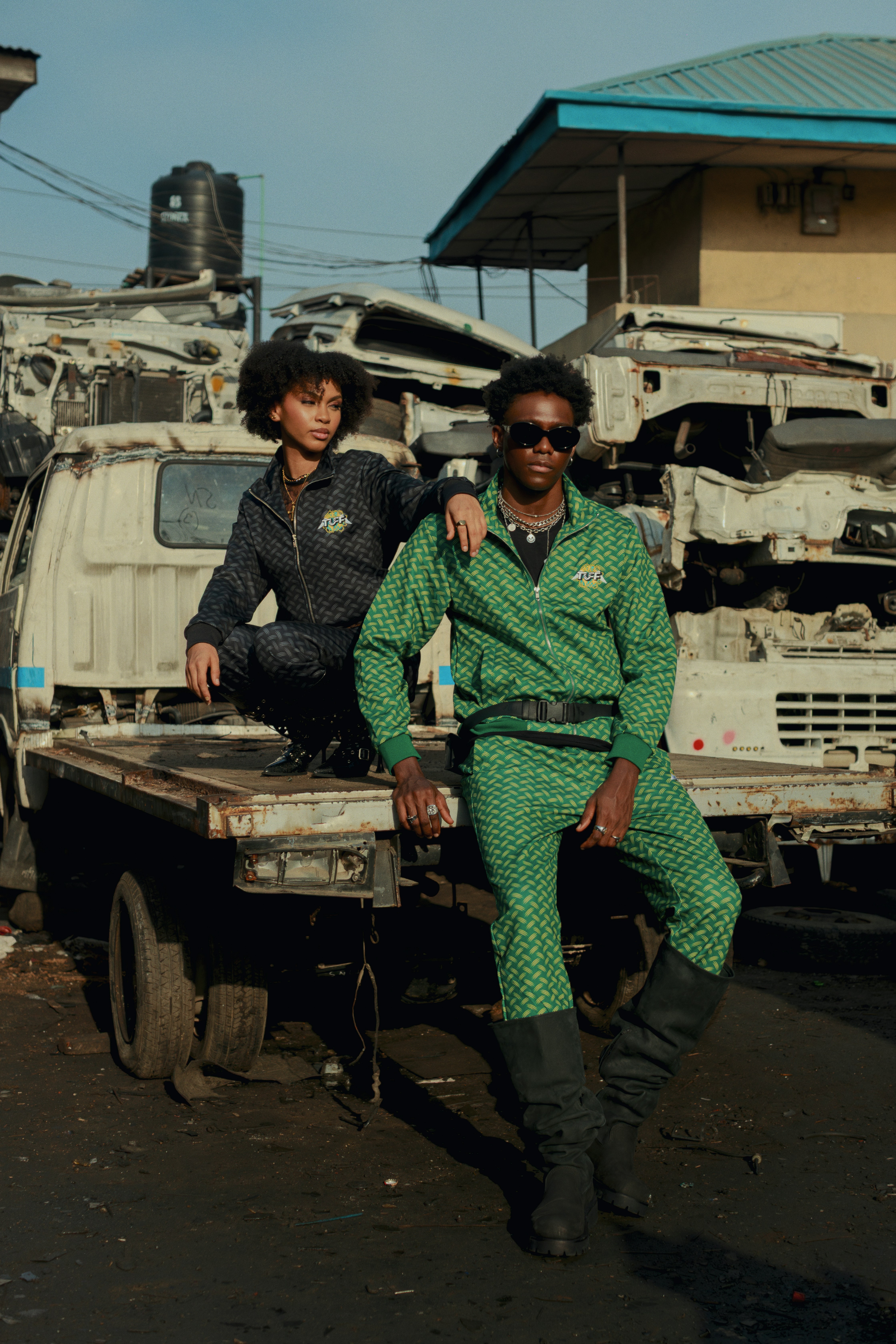 Industrial Chrome: Two Models in a Scrapyard Retreat