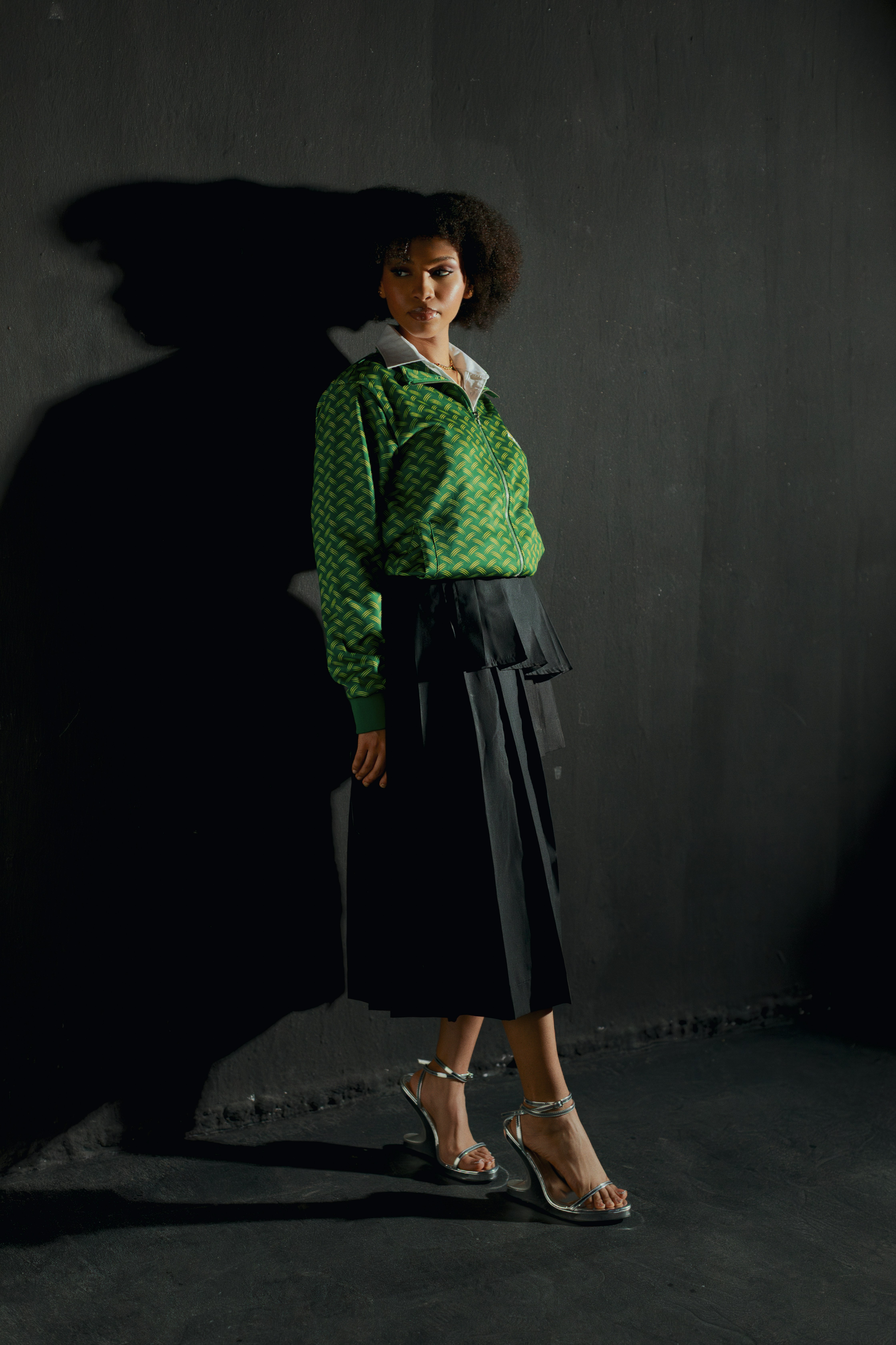 Green Pattern, Black Silhouette: A Quiet Portrait in Light and Shadow