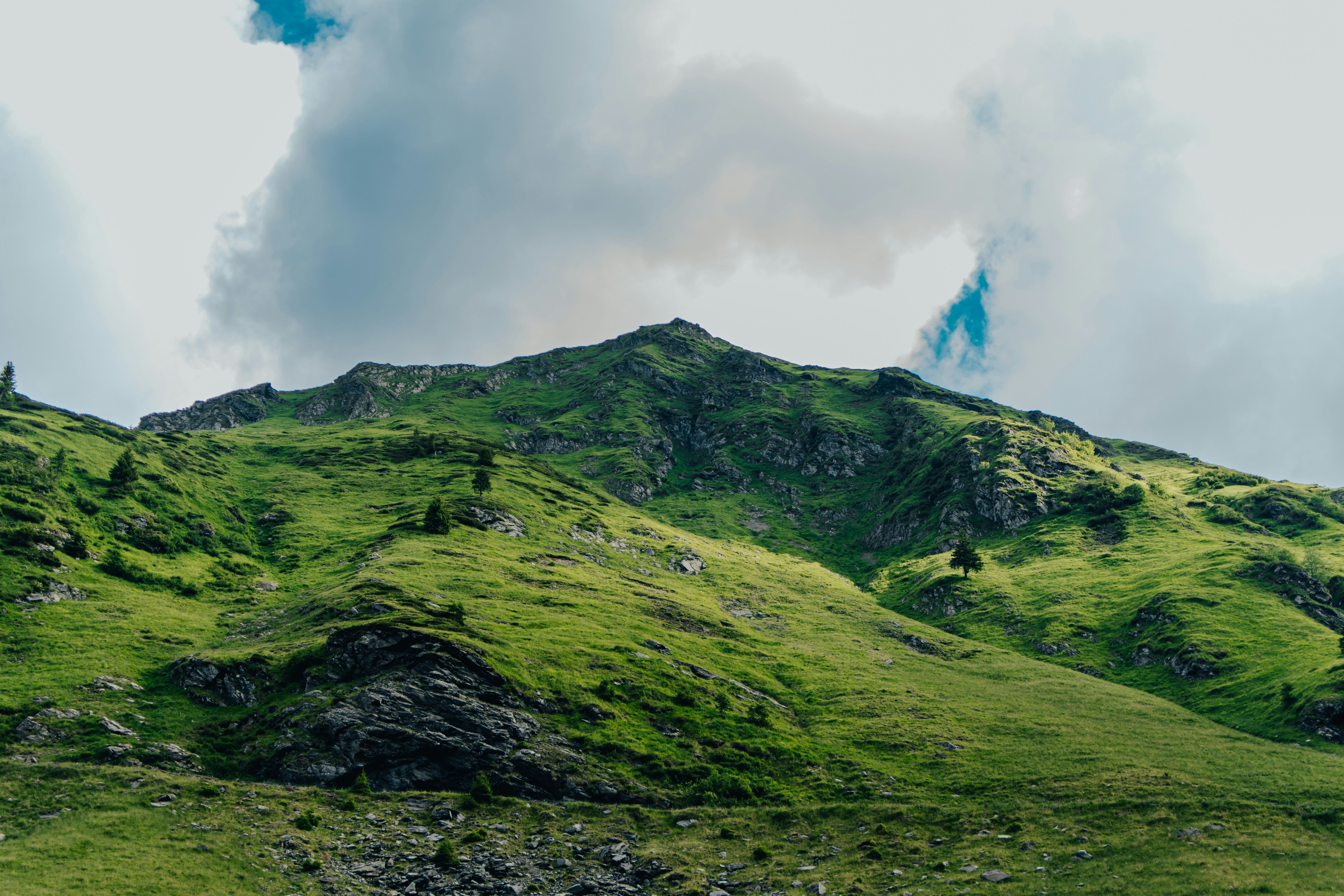 Verdant Ridge: Rolling Hills Under a Break in Clouds