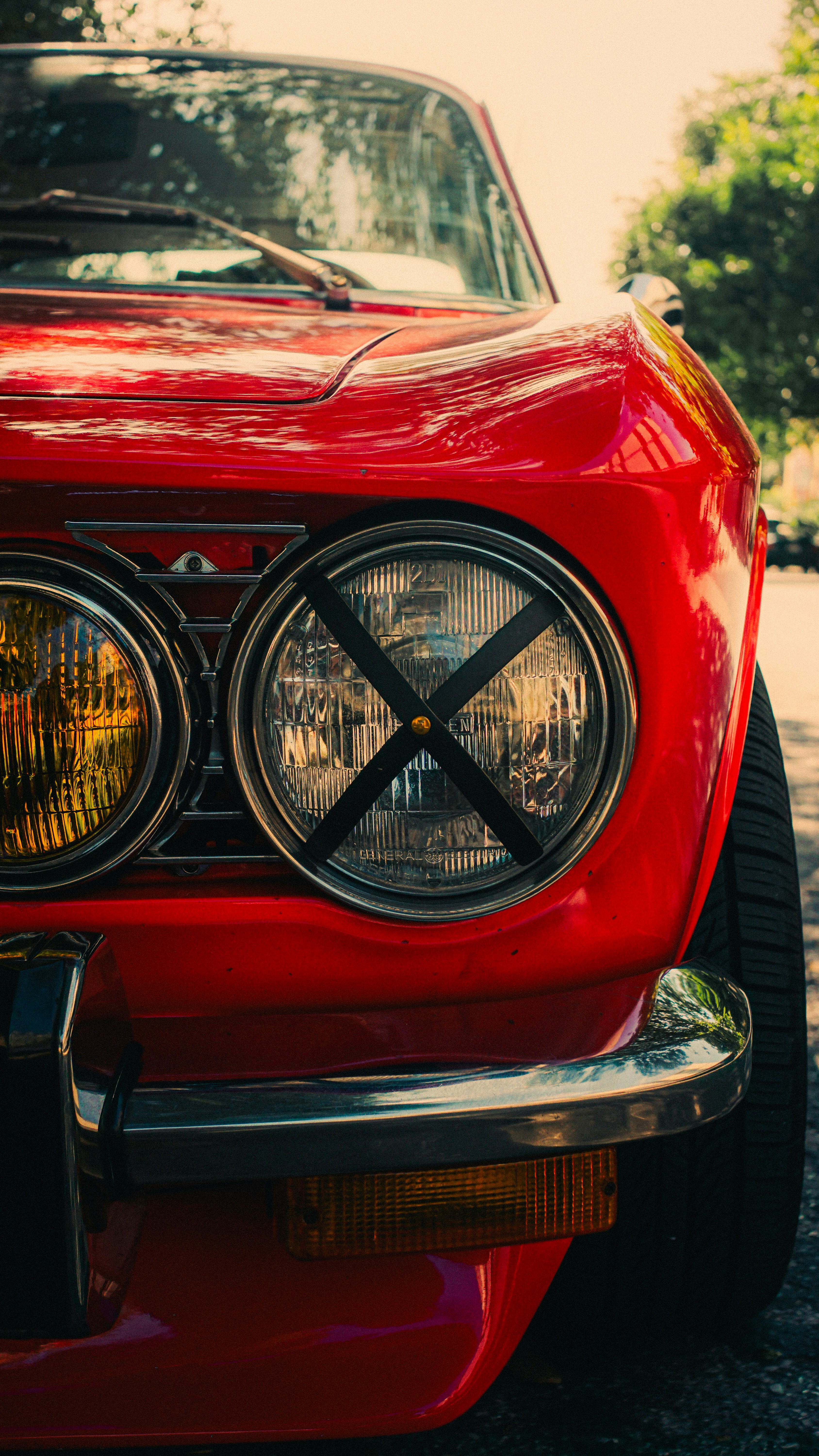 Crimson Headlights: A Classic Car’s Front Portrait