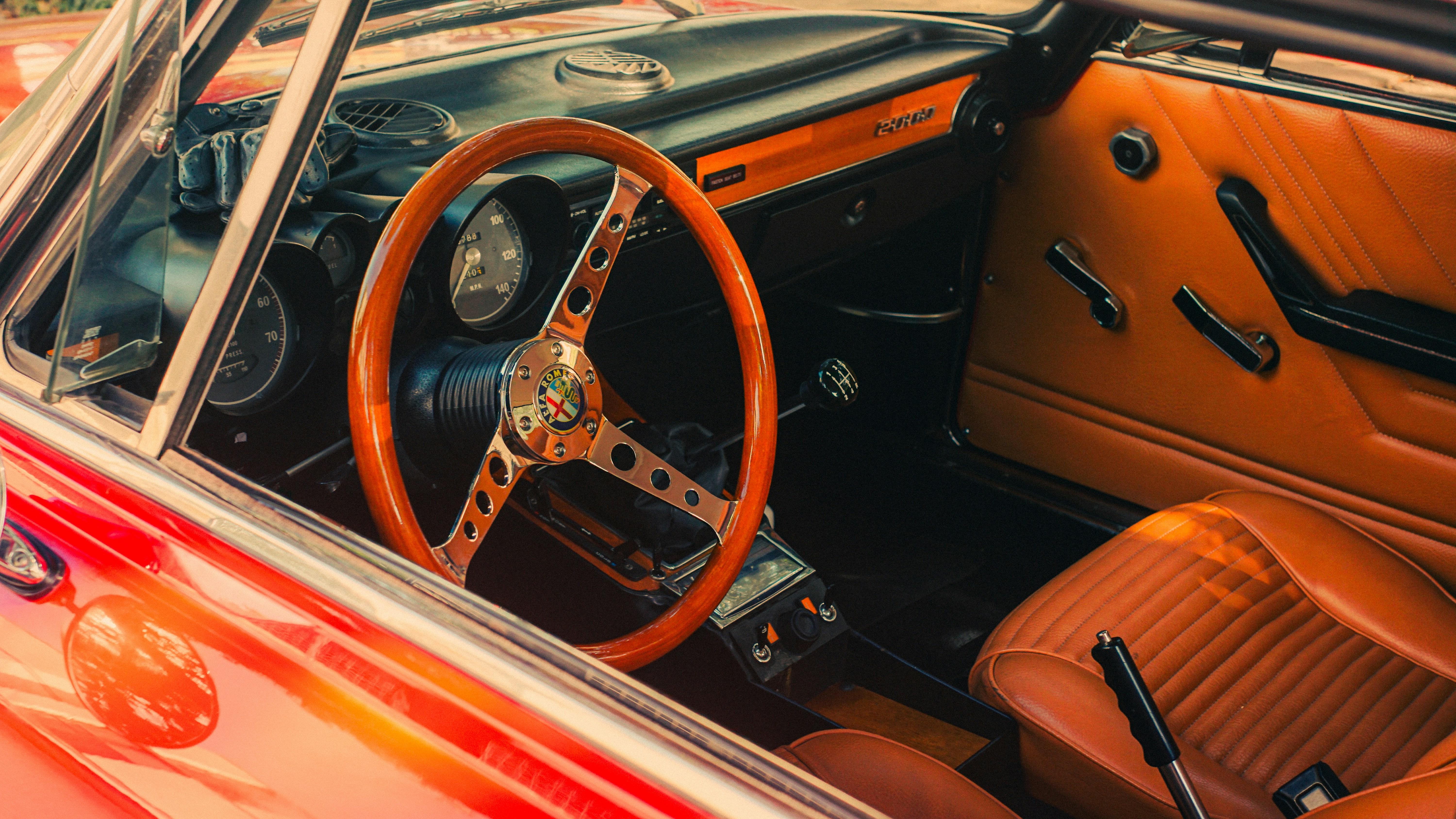 Retro Cockpit: A Stern Wooden Steering Wheel in a Tangerine Cabin