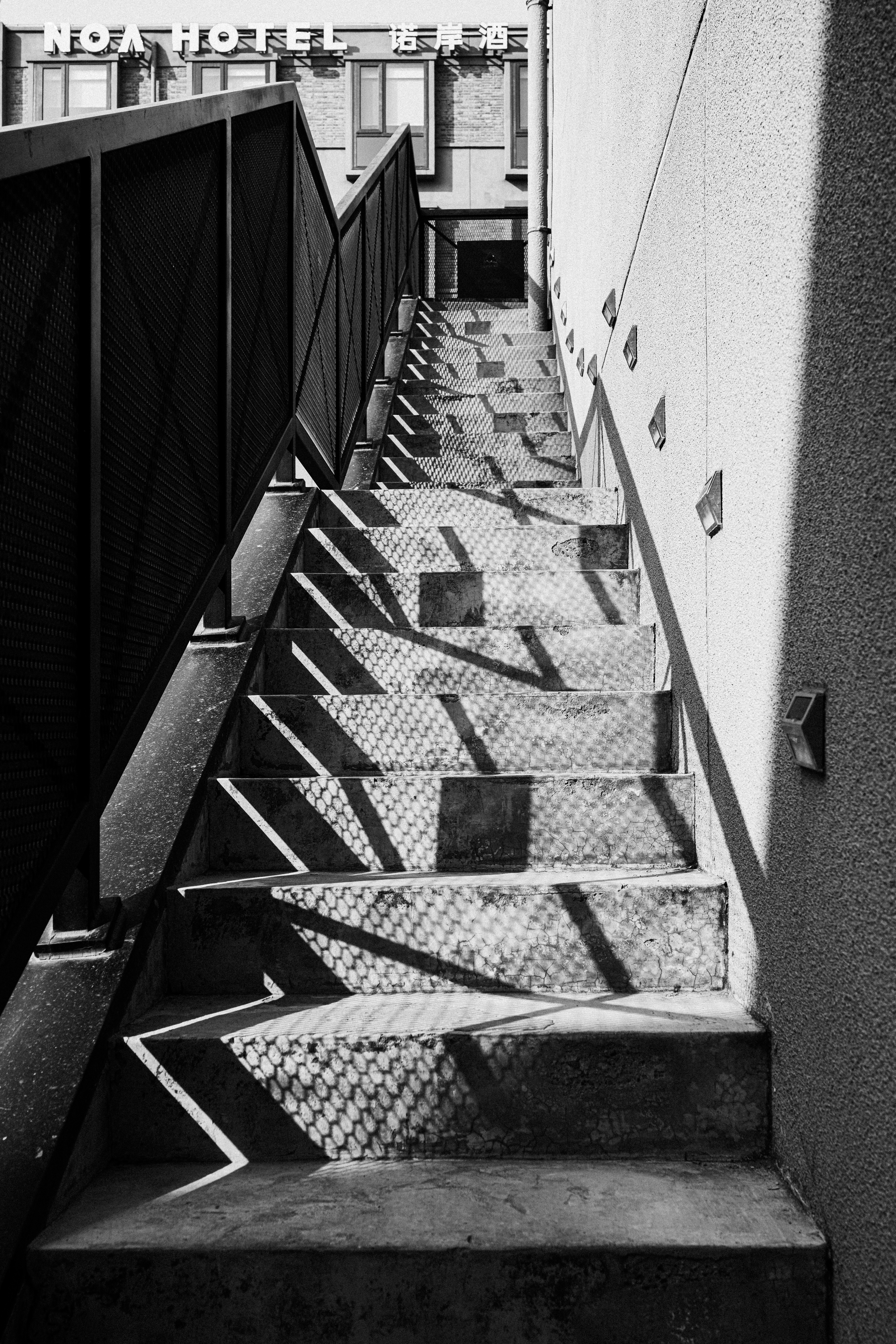Staircase as Shadowplay: A Grim Geometry of Concrete and Rail