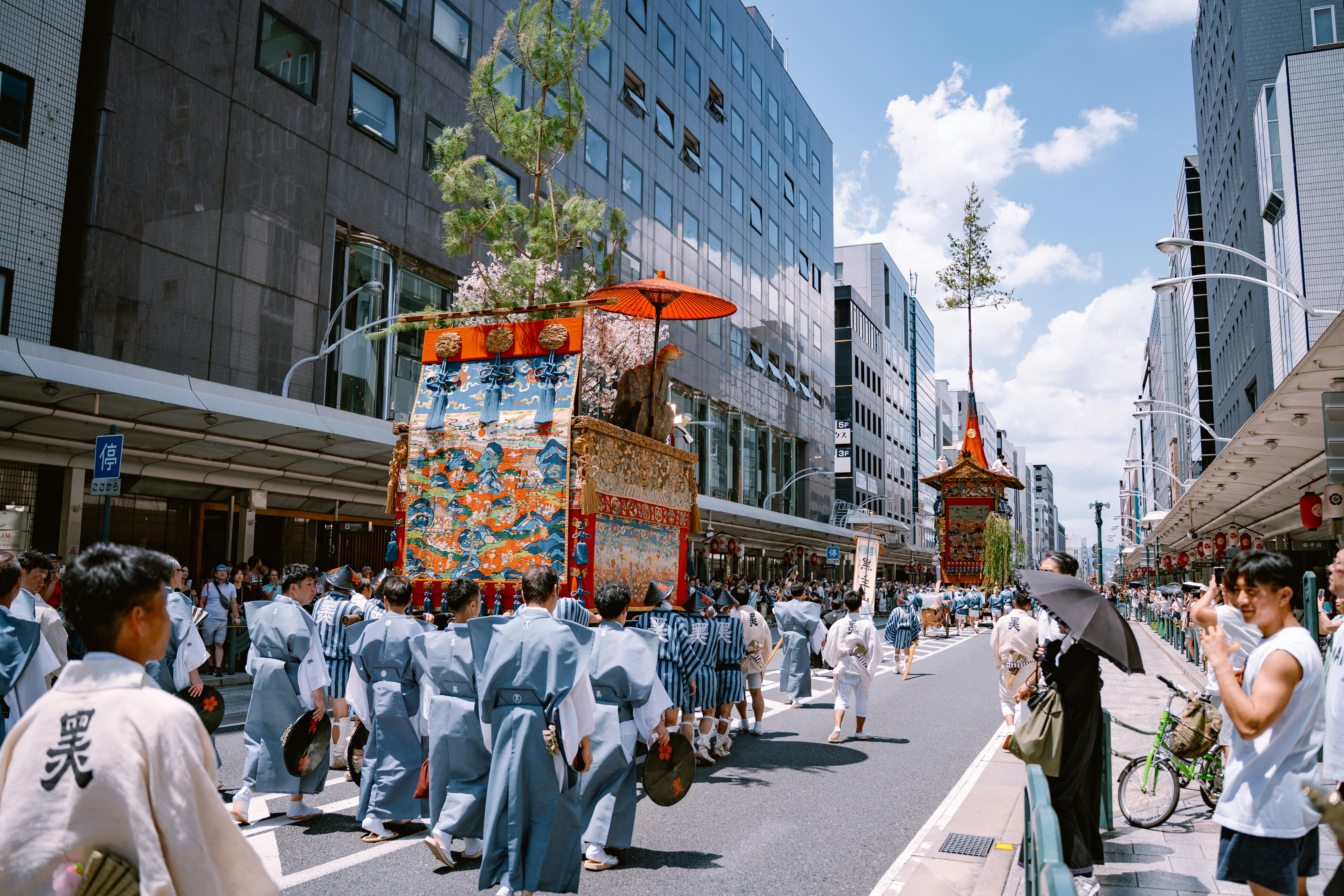 Procession Down a Tokyo Street: Robed Performers and a Joyful Crowd