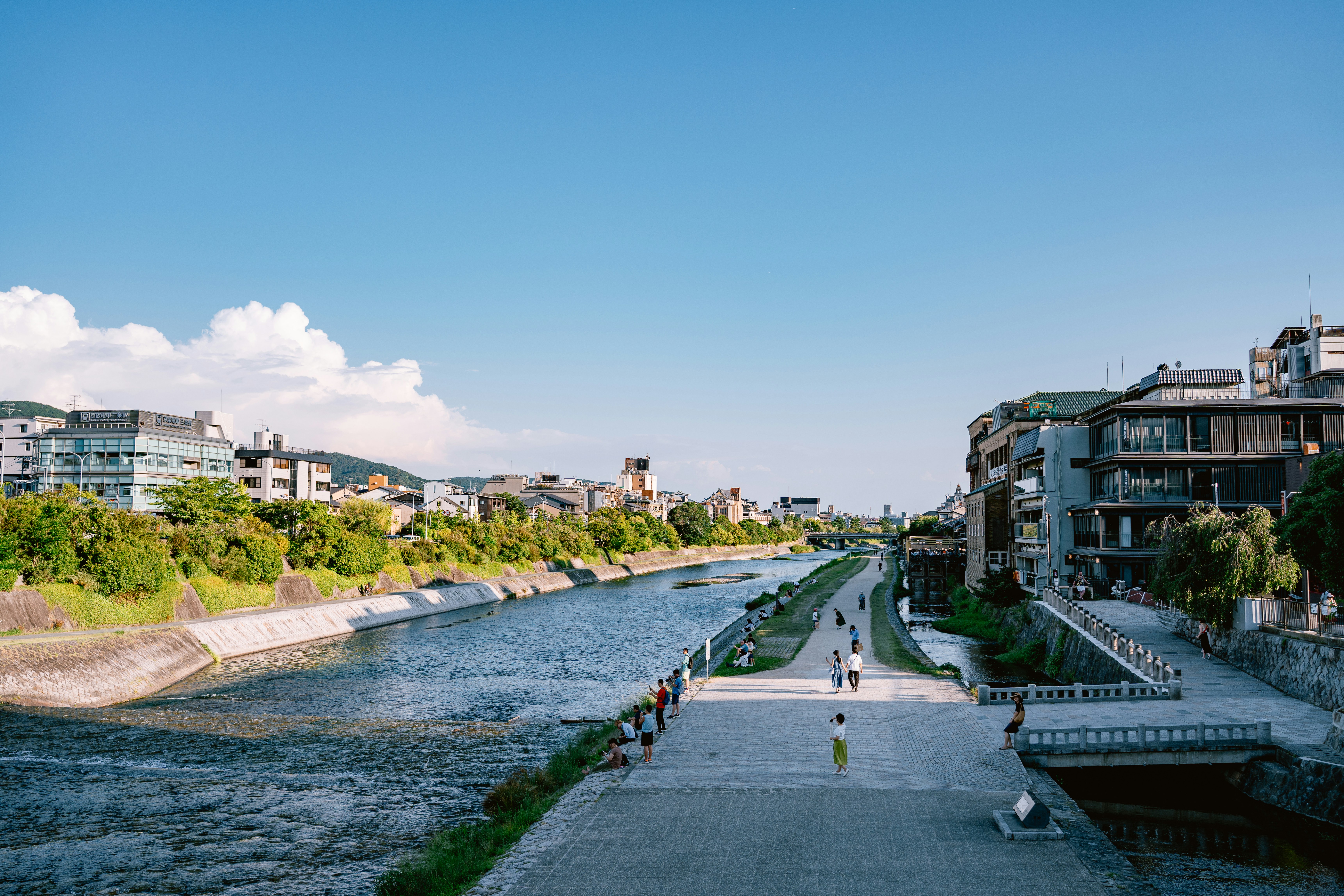 Riverside Axis: Sunlit Path Through a Modern Waterfront Quarter
