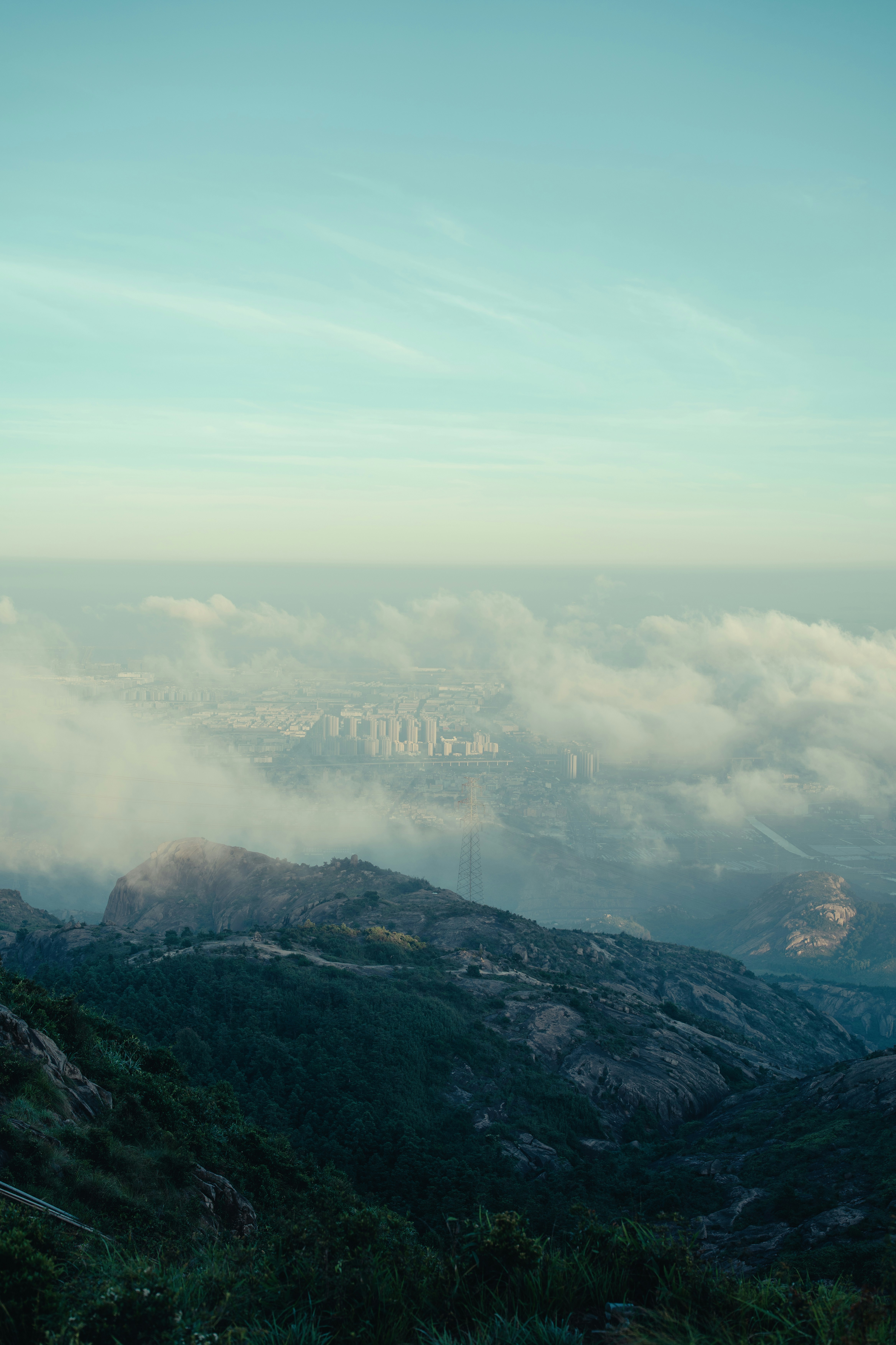 Cloud-Capped Ridge Overlooking a Quiet City Horizon