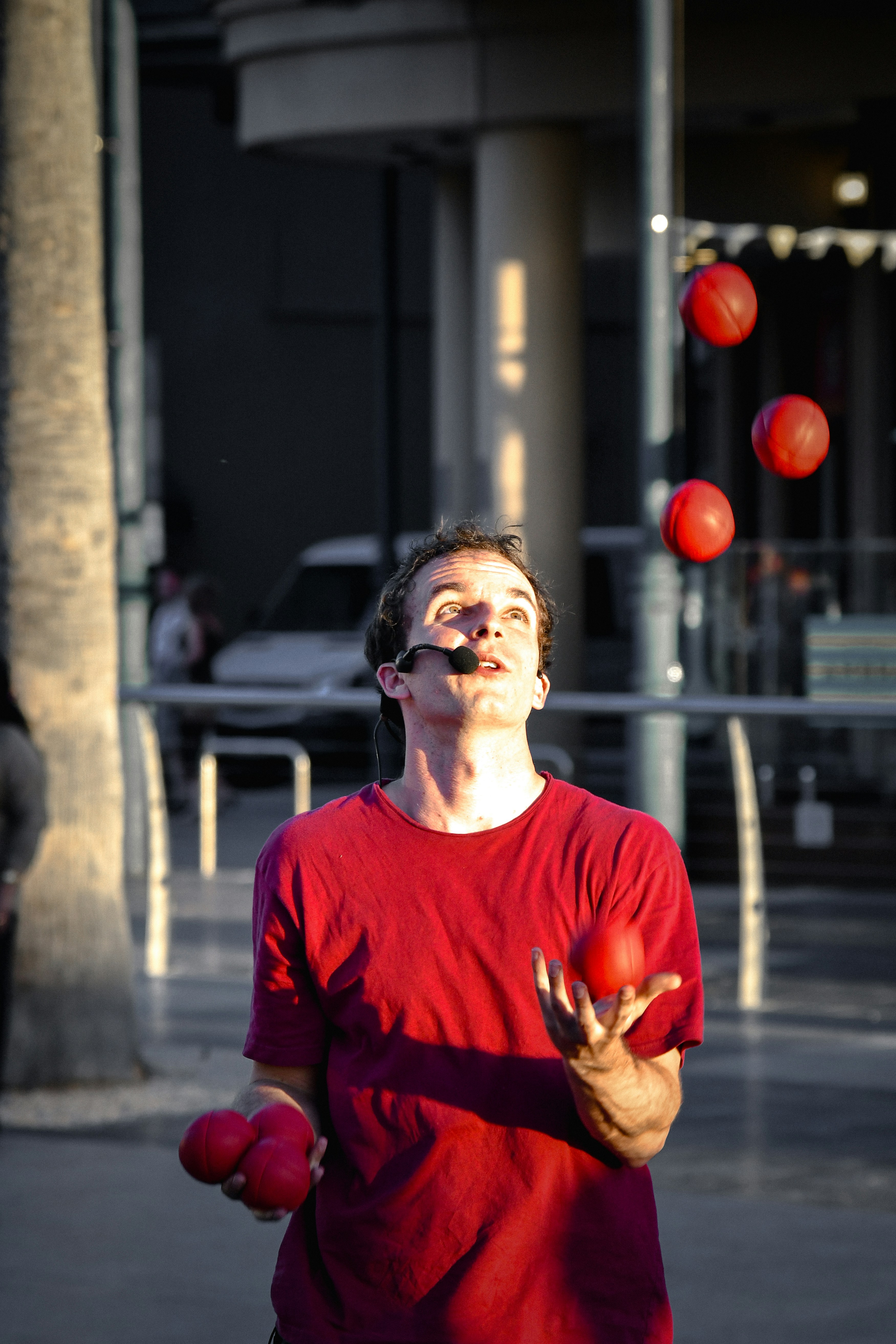 Red-clad Juggler Under City Lights