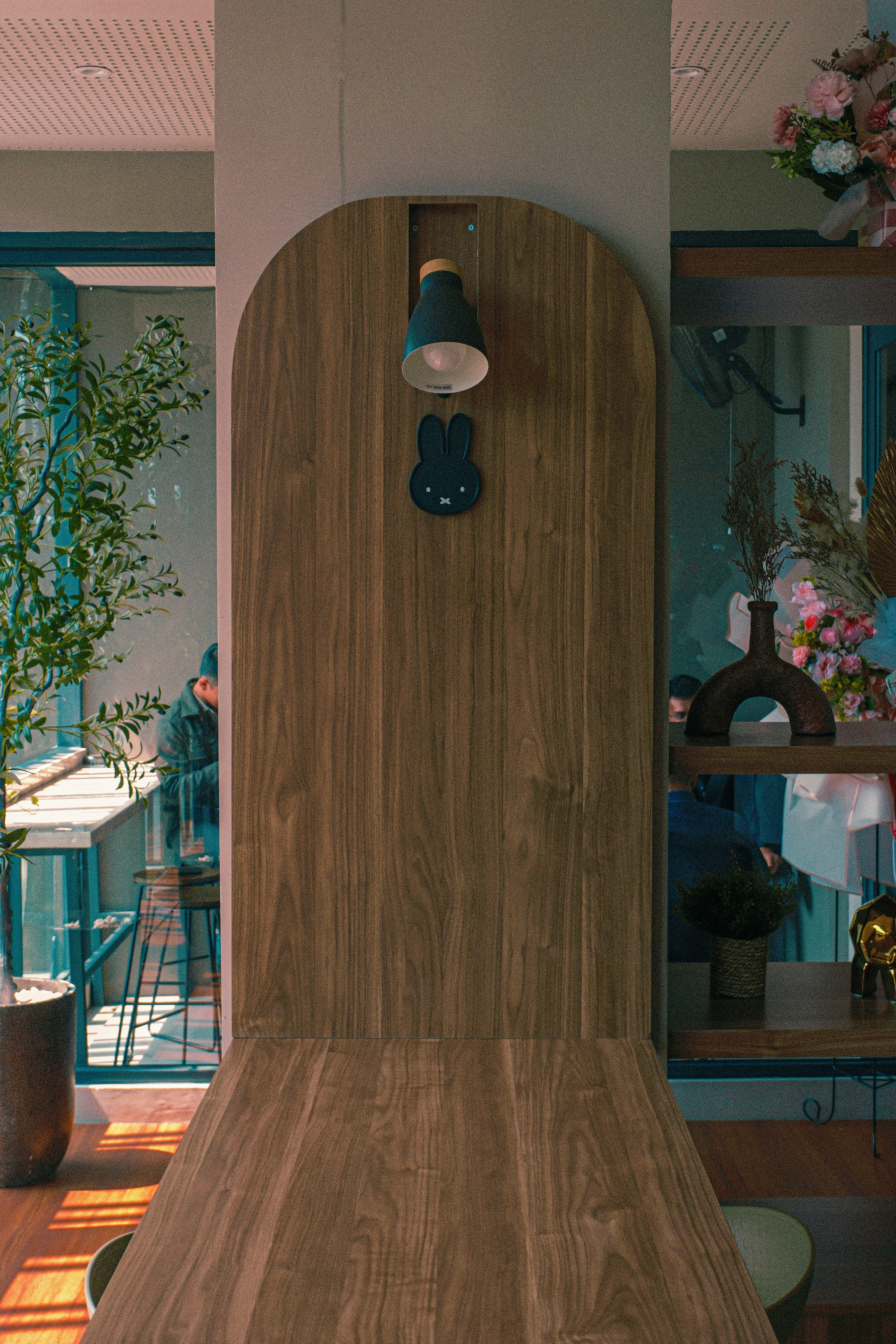 Wooden partition with bunny wall decor inside a cozy cafe