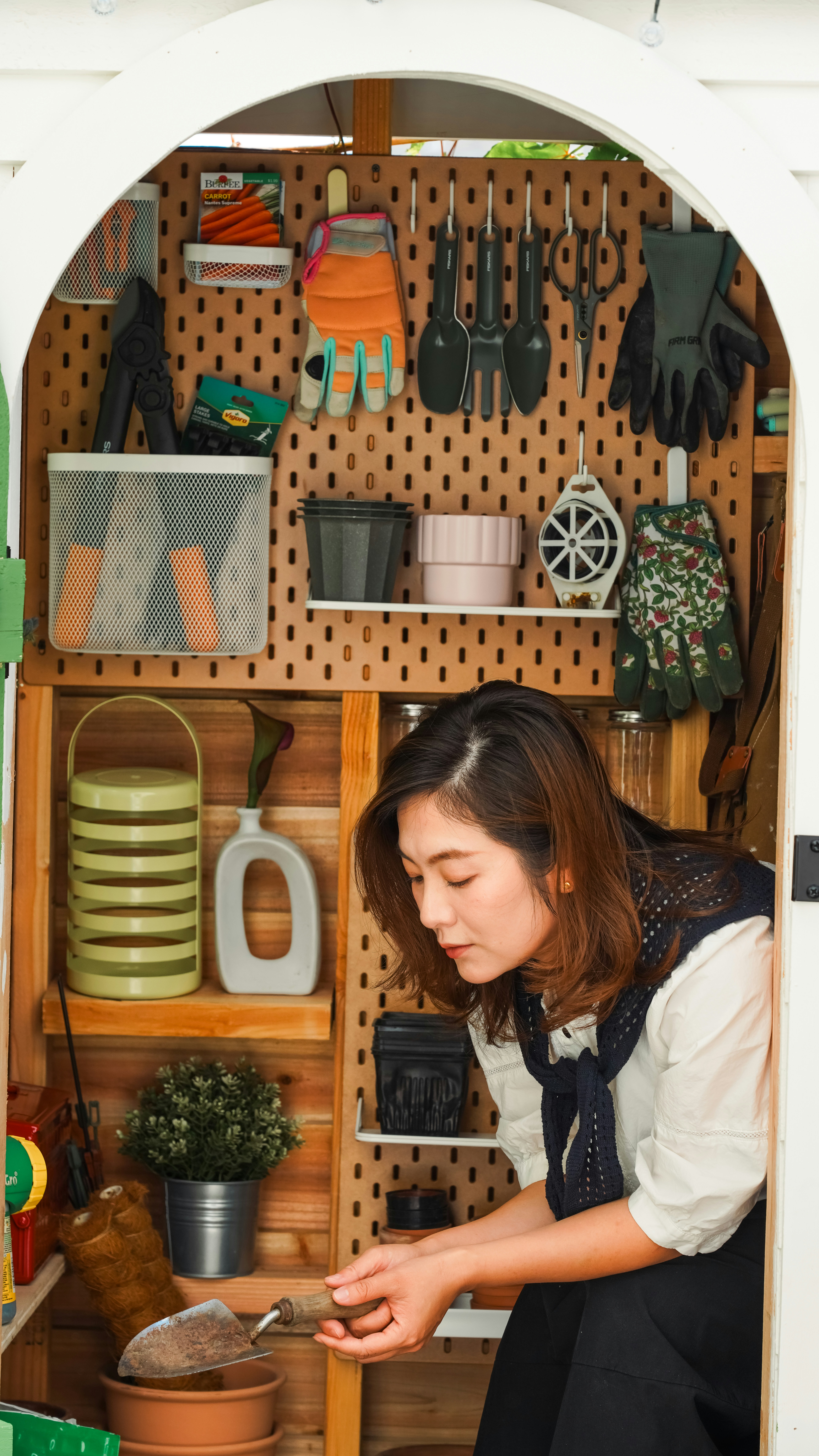 Studio Gardener: The Hand in Motion Over a Tidy Workbench