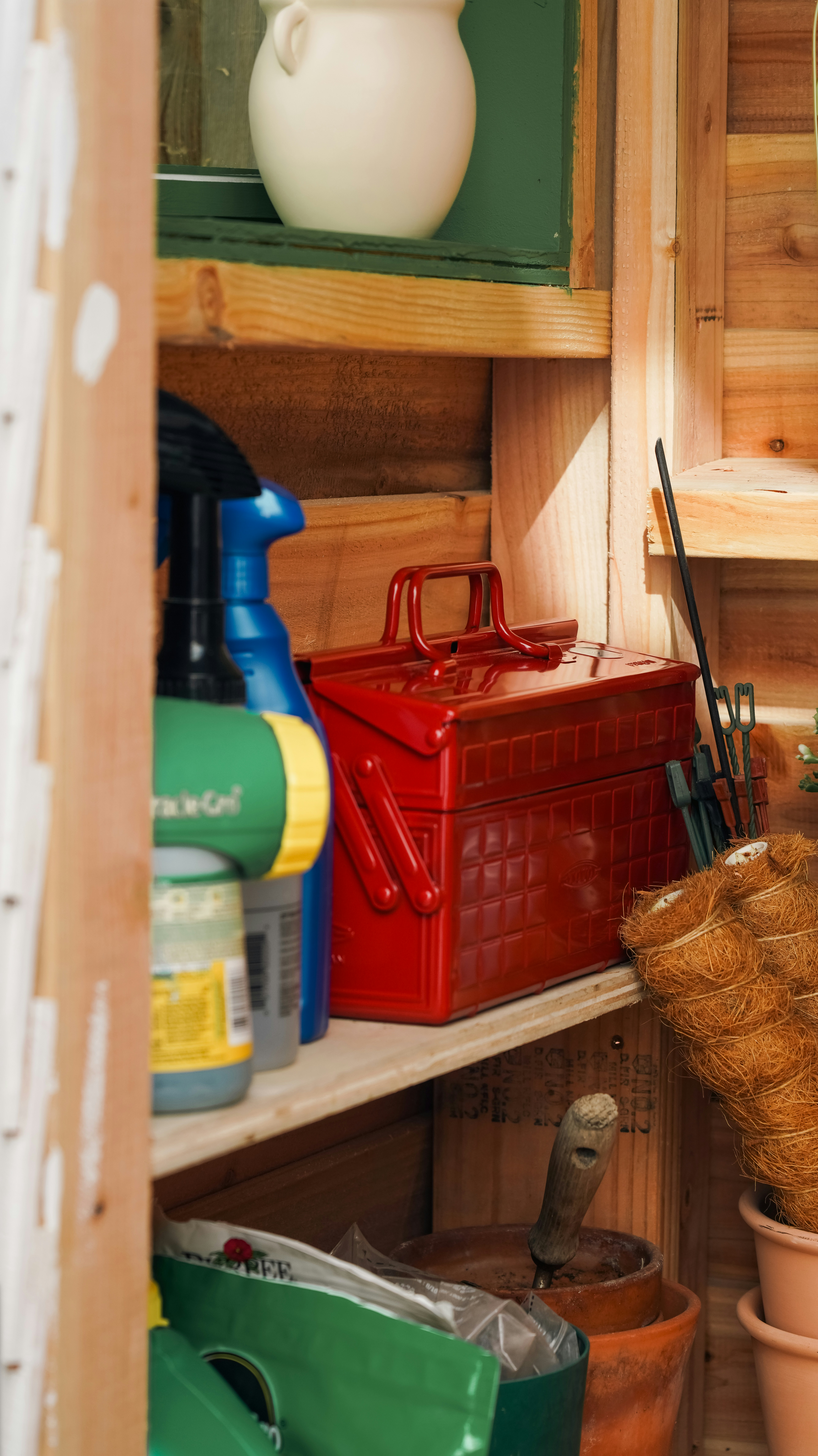 A Corner of the Shed: Red Toolbox and Tools in Wooden Nook