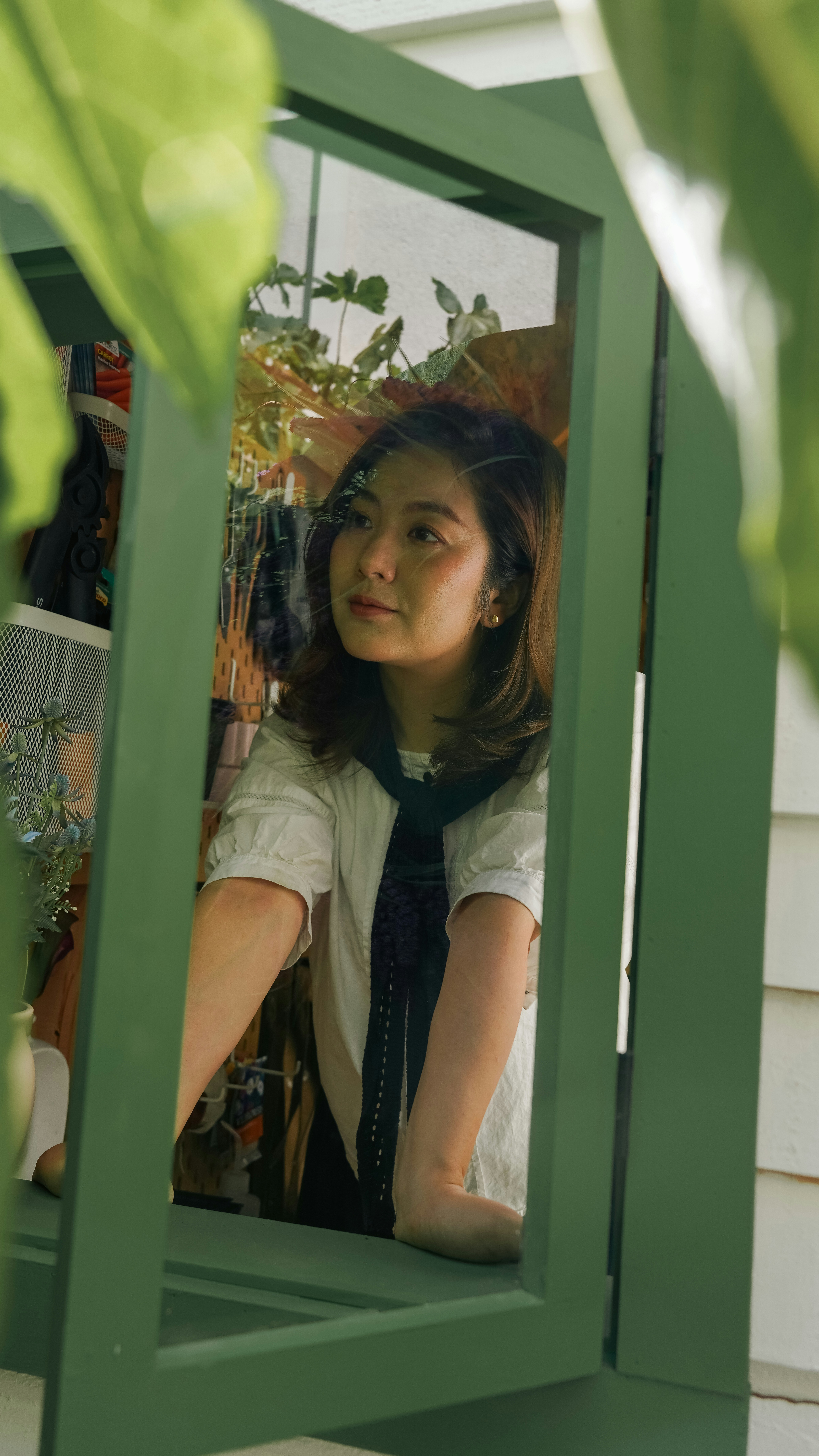 Reflected contemplations: a portrait in a green doorway