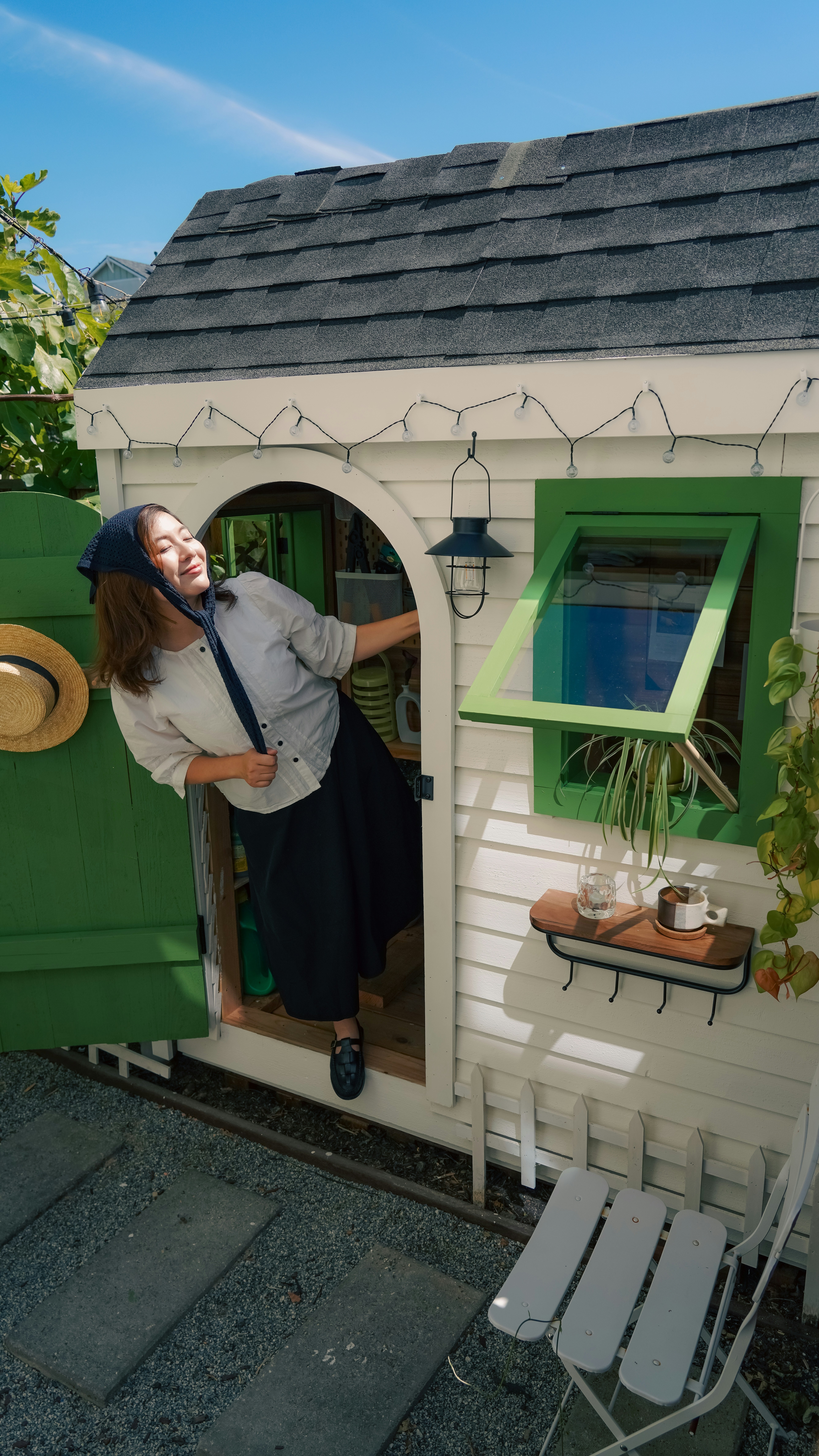 Curved doorway, sunlight, and a playful entry into a colorful shed