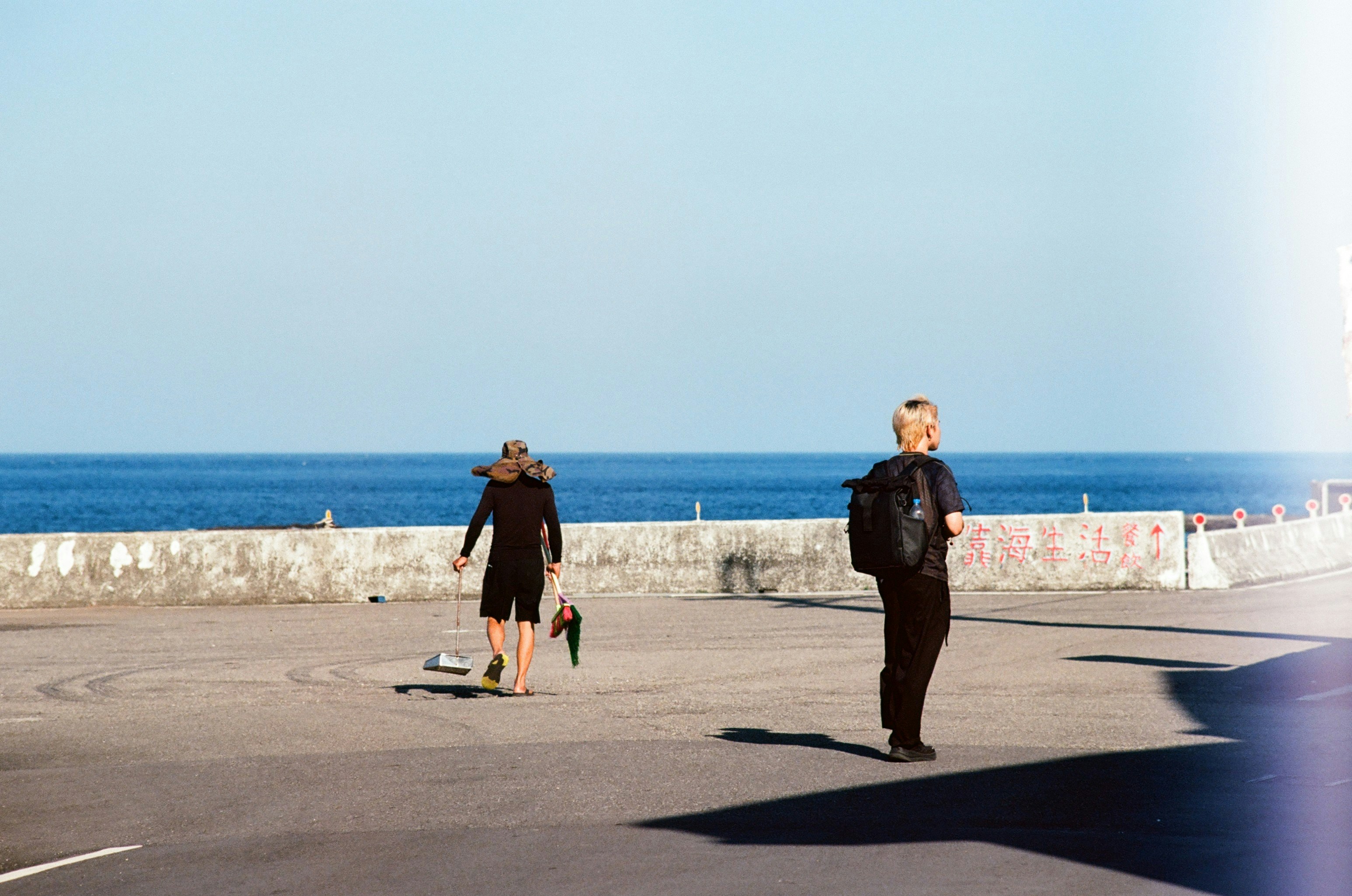 Two Figures by the Sea: A Quiet Moment on the Pier