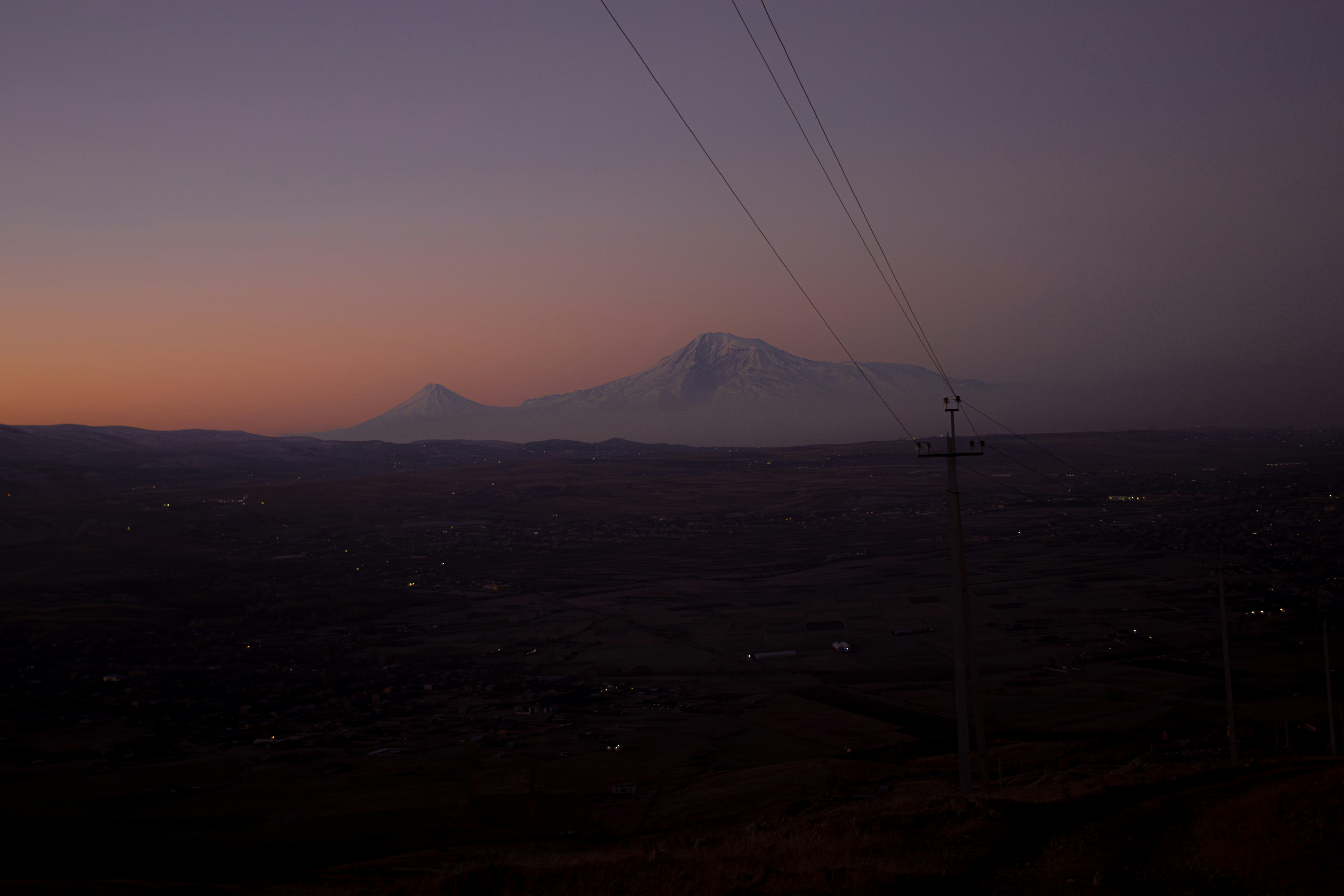 Distant Peaks Under a Twilight Grid