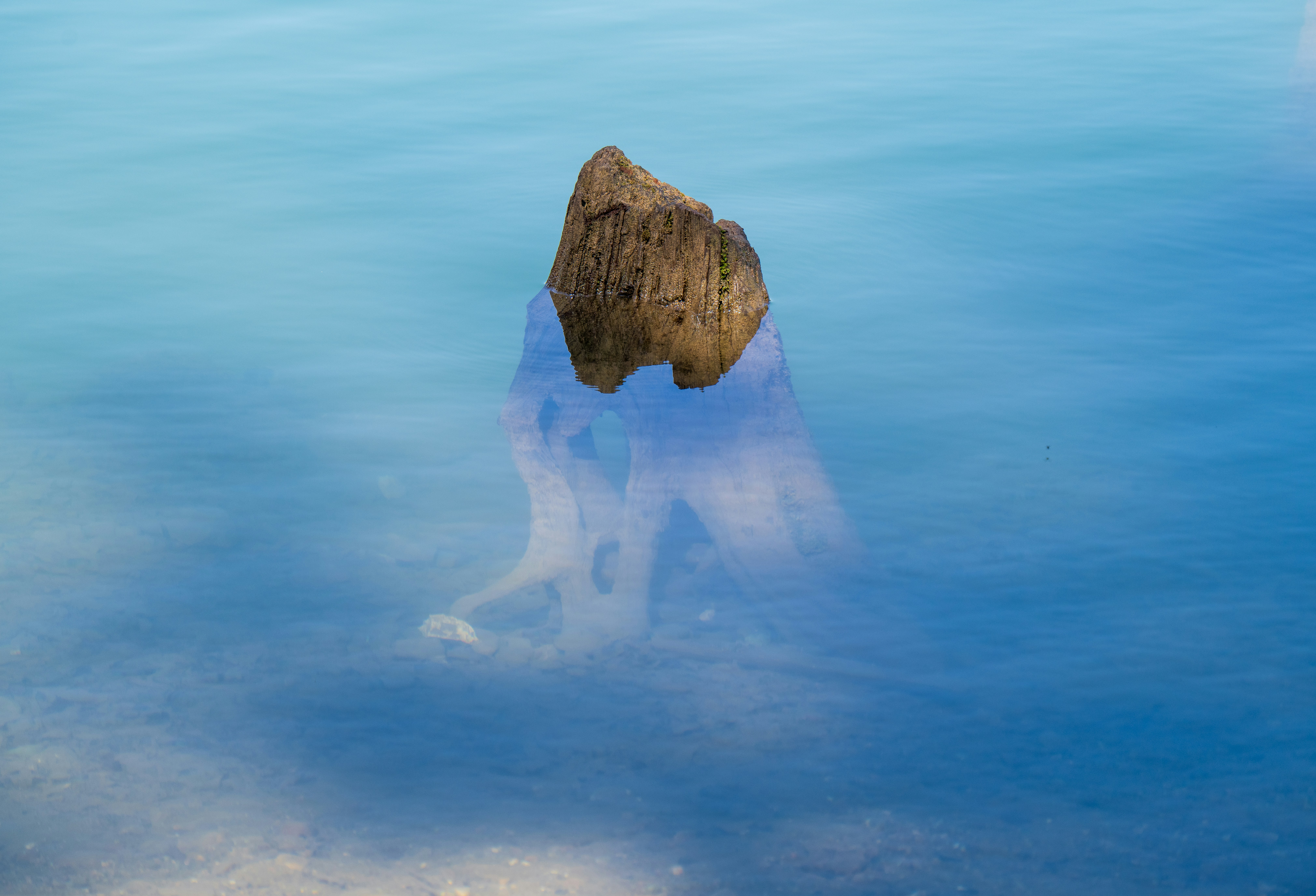 Isolated Stone Pierced by Quiet Waters