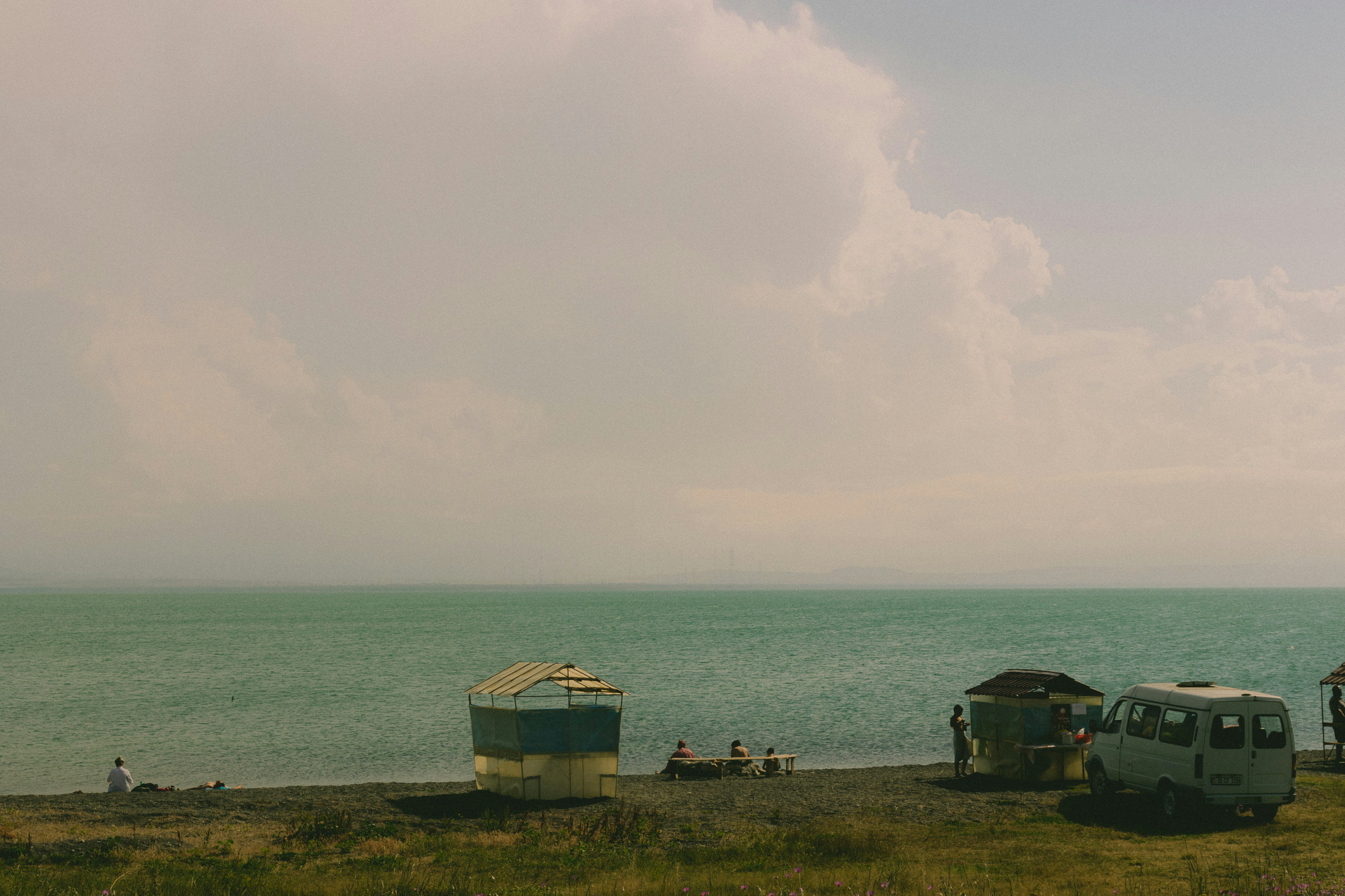 Coastal Lane: A Quiet Shorefront with Tiny Dwellings and a Van