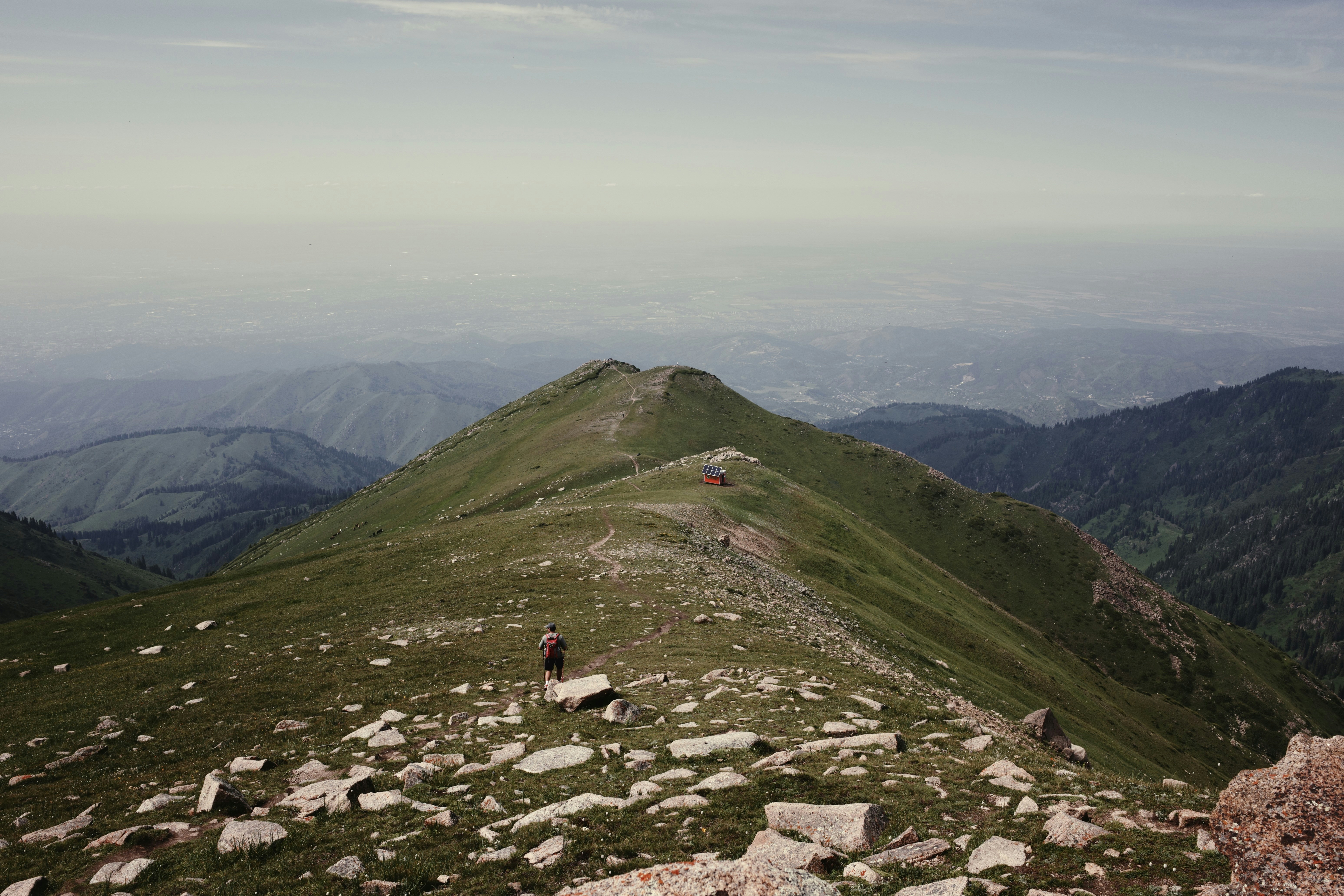 Trail Crest on a Rocky Ridge Beneath a Vast Alpine Sky