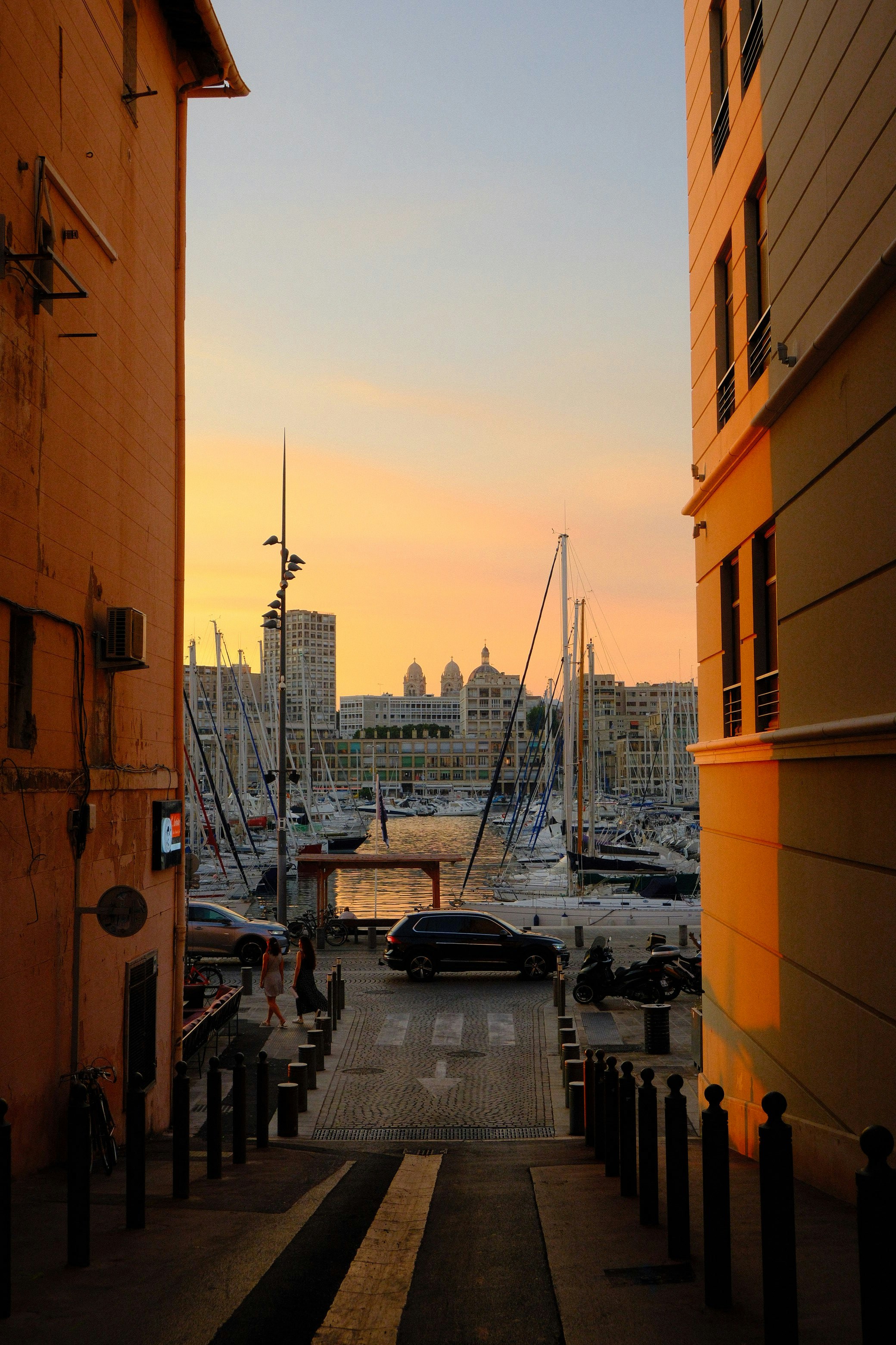 Sunset Passage: Boats, Bridges and Narrow Streets Framing a Harbor Fate