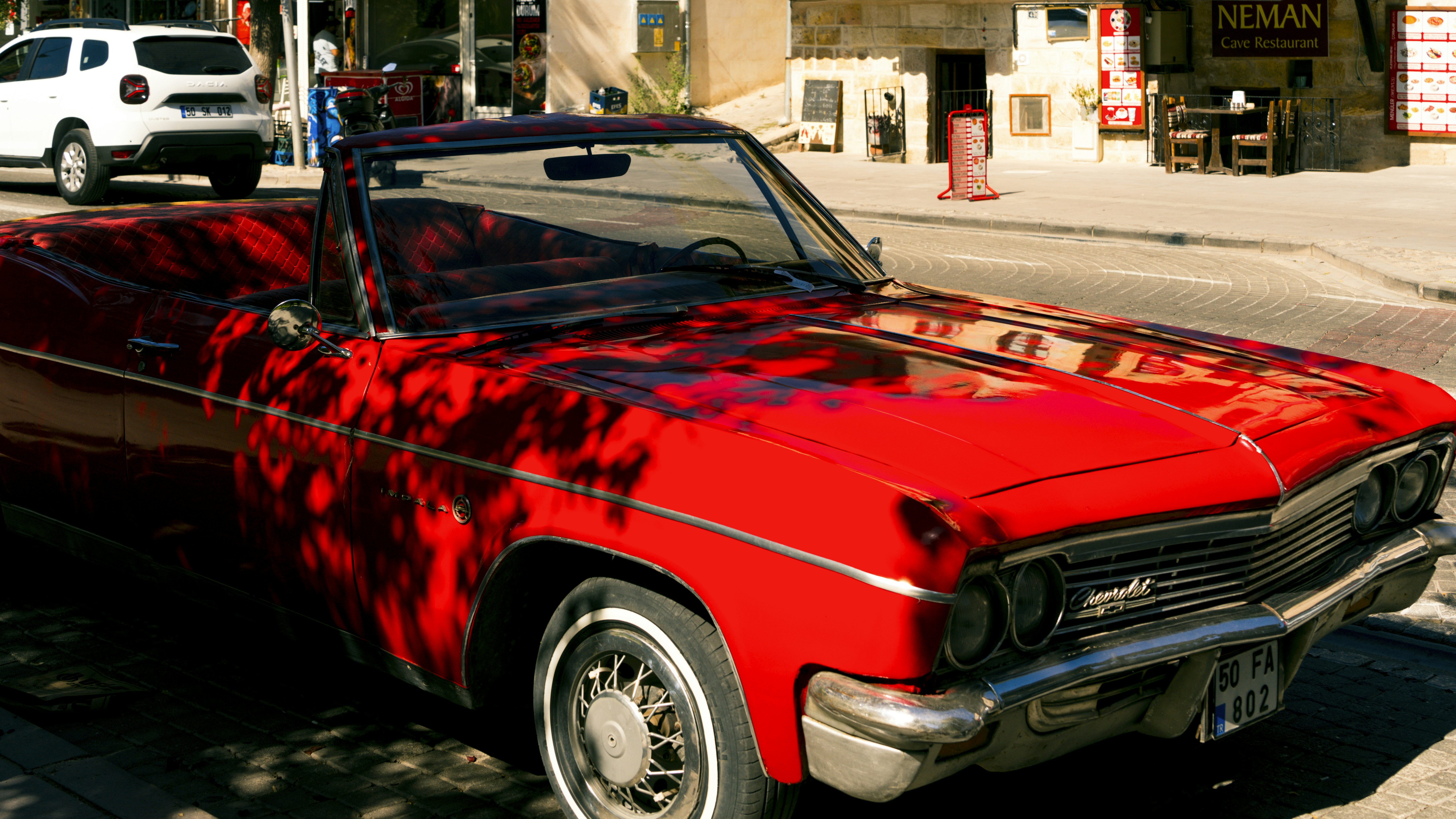 Red Convertible in Partial Sunlight: Classic Car Portrait