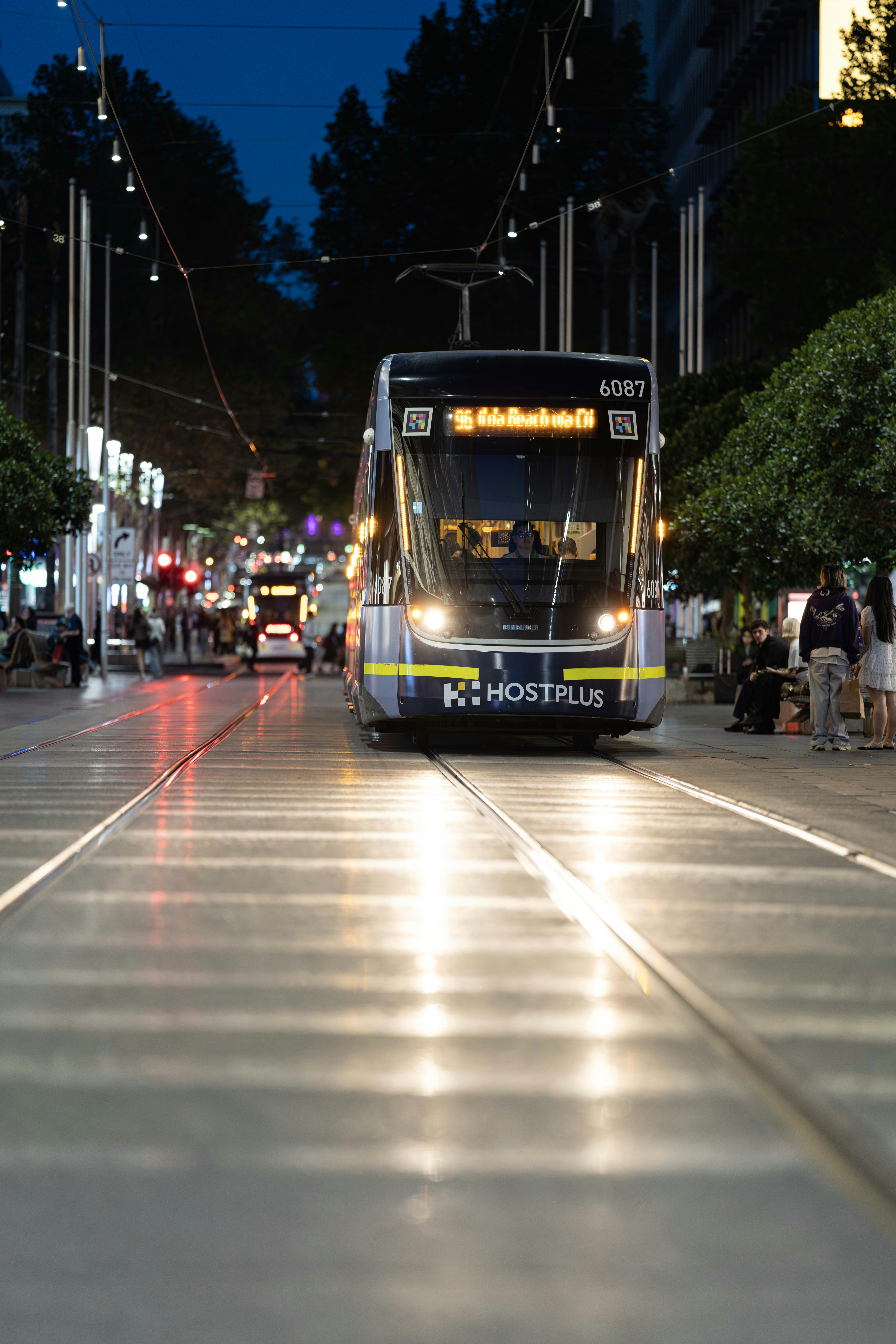 Midnight tram on a glowing city street