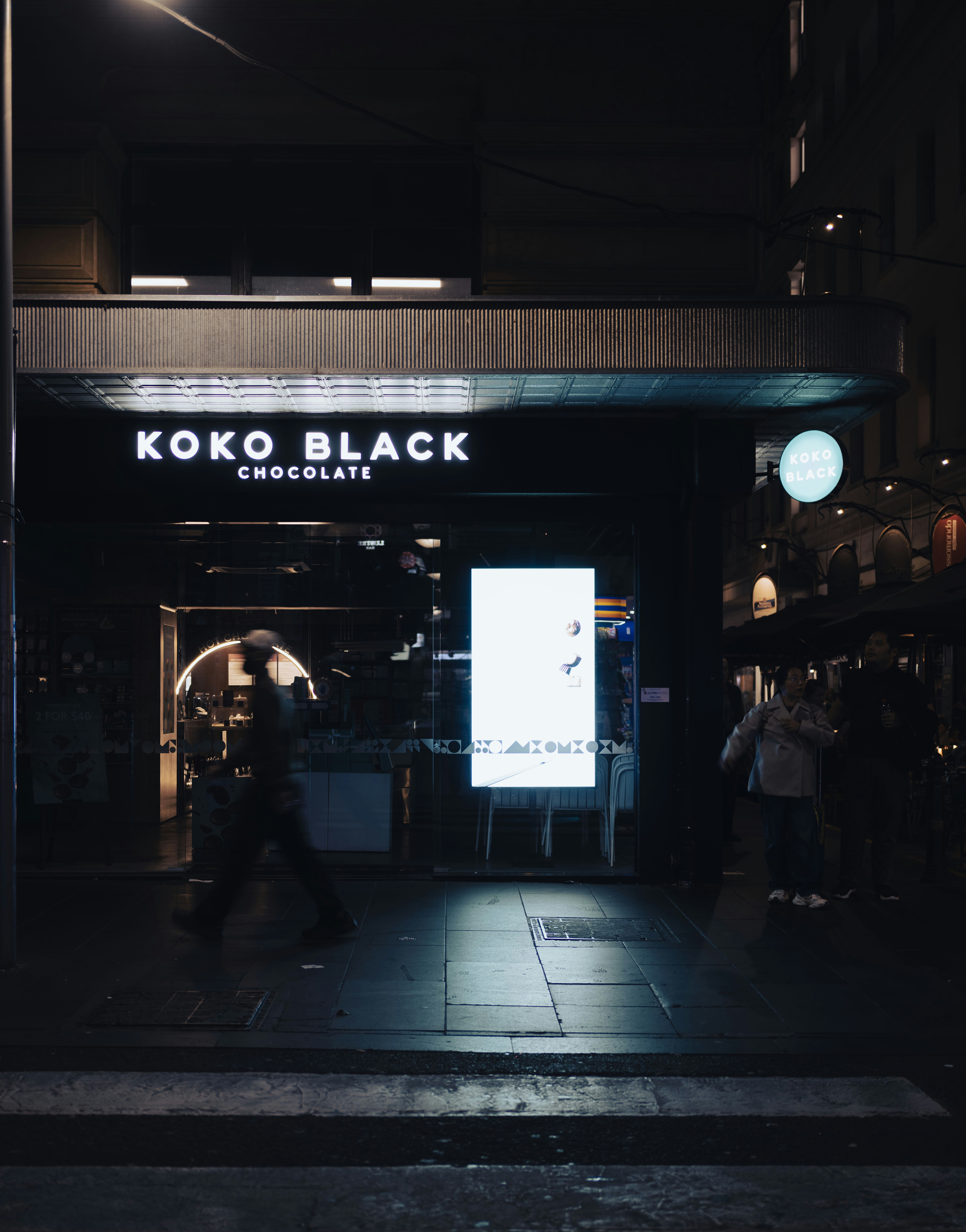 Neon Nightfront: Koko Black Glow on a Busy Street