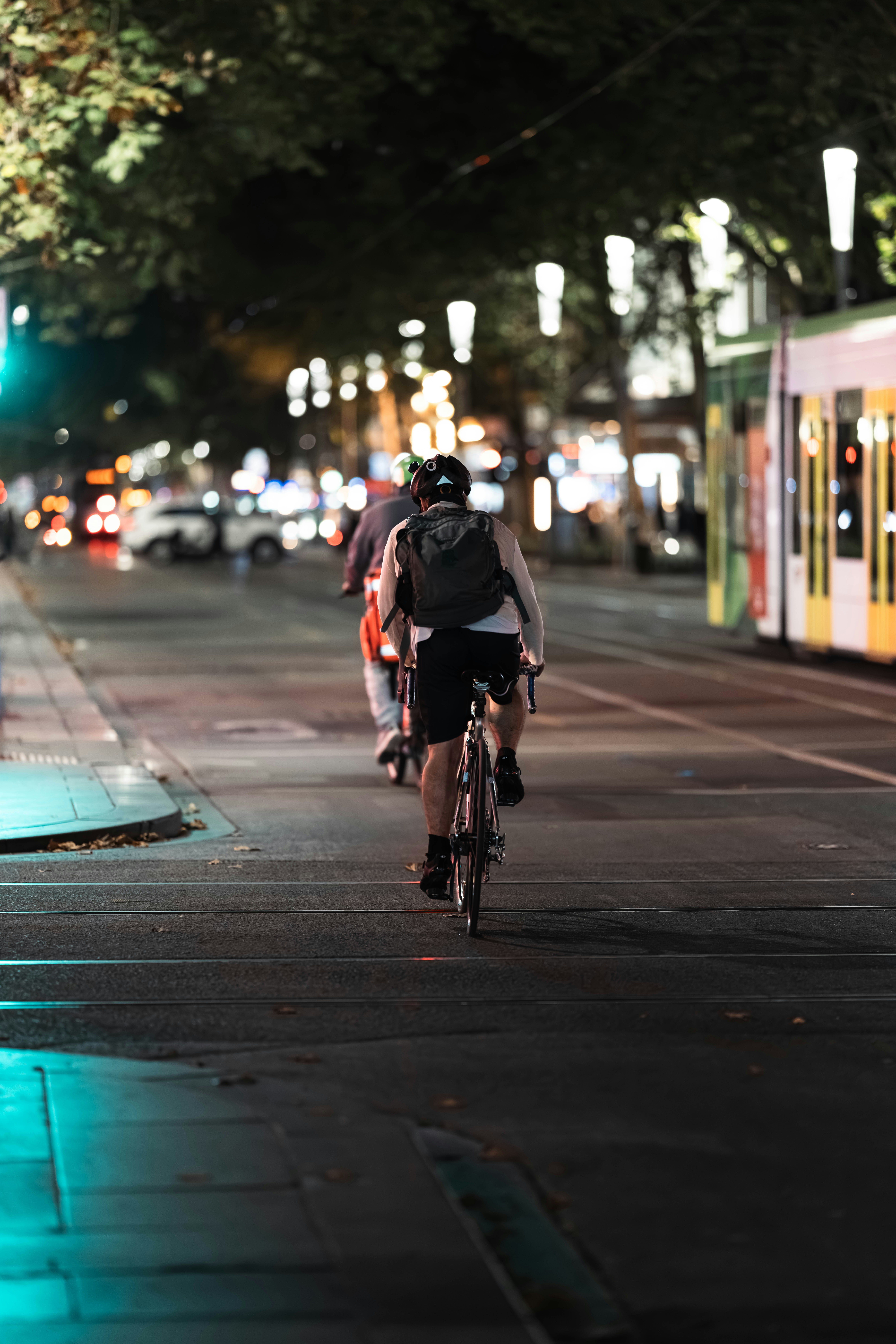 Night Rider: A Solo Cyclist Pushing Through Neon City Lights