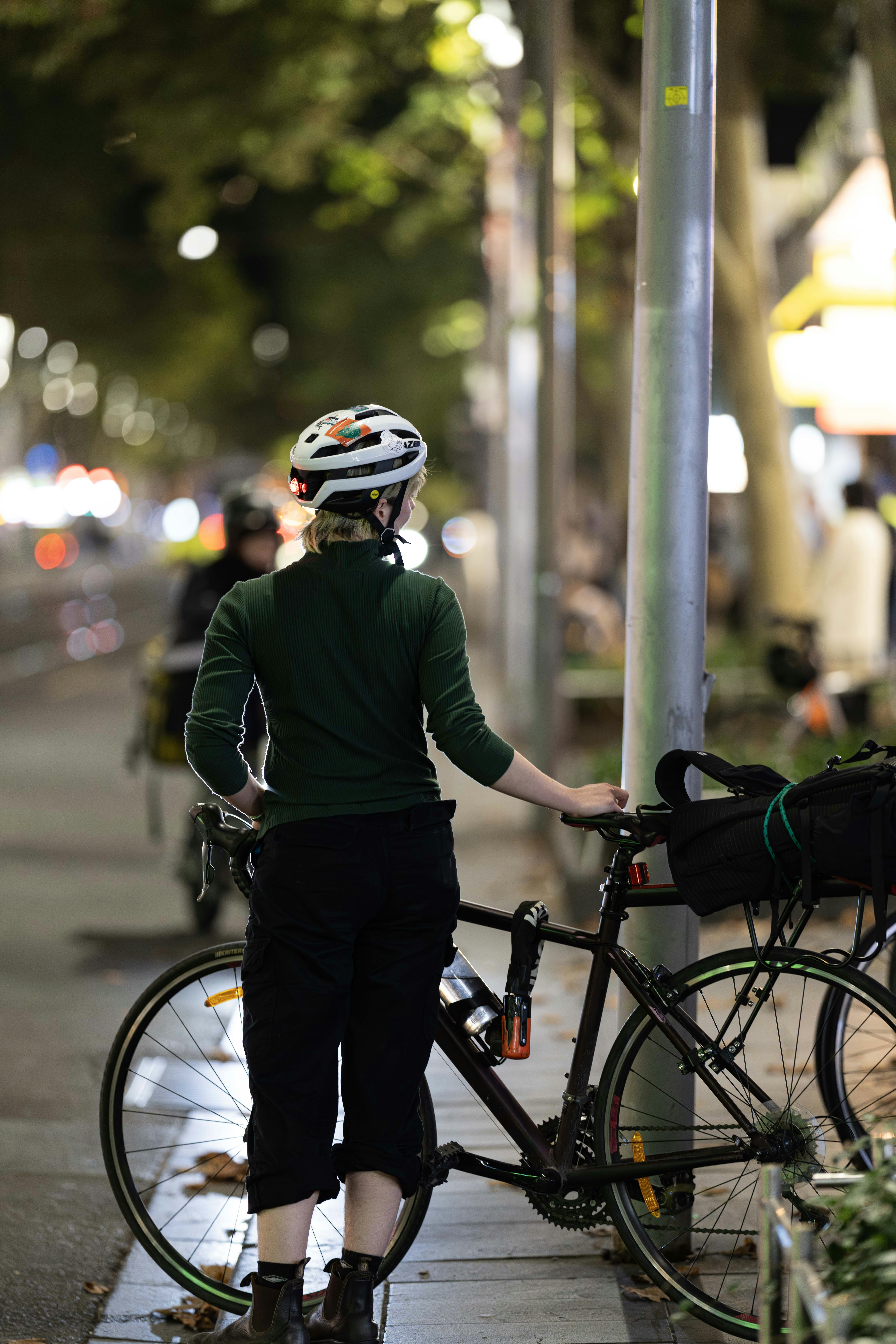 Cyclist in Evening Street: A Pause by the Bike Night