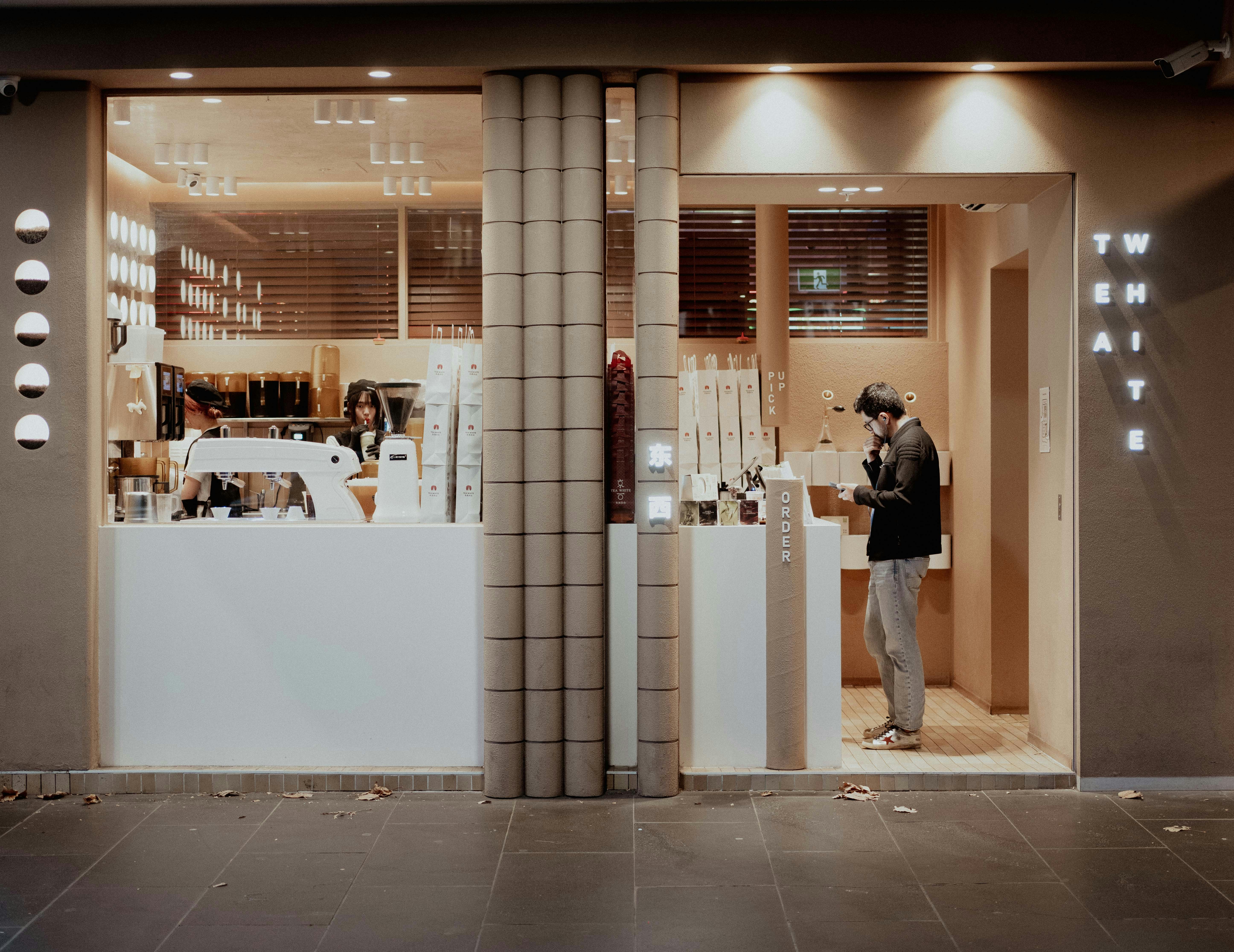 Neon-lit storefront: a quiet moment between two strangers