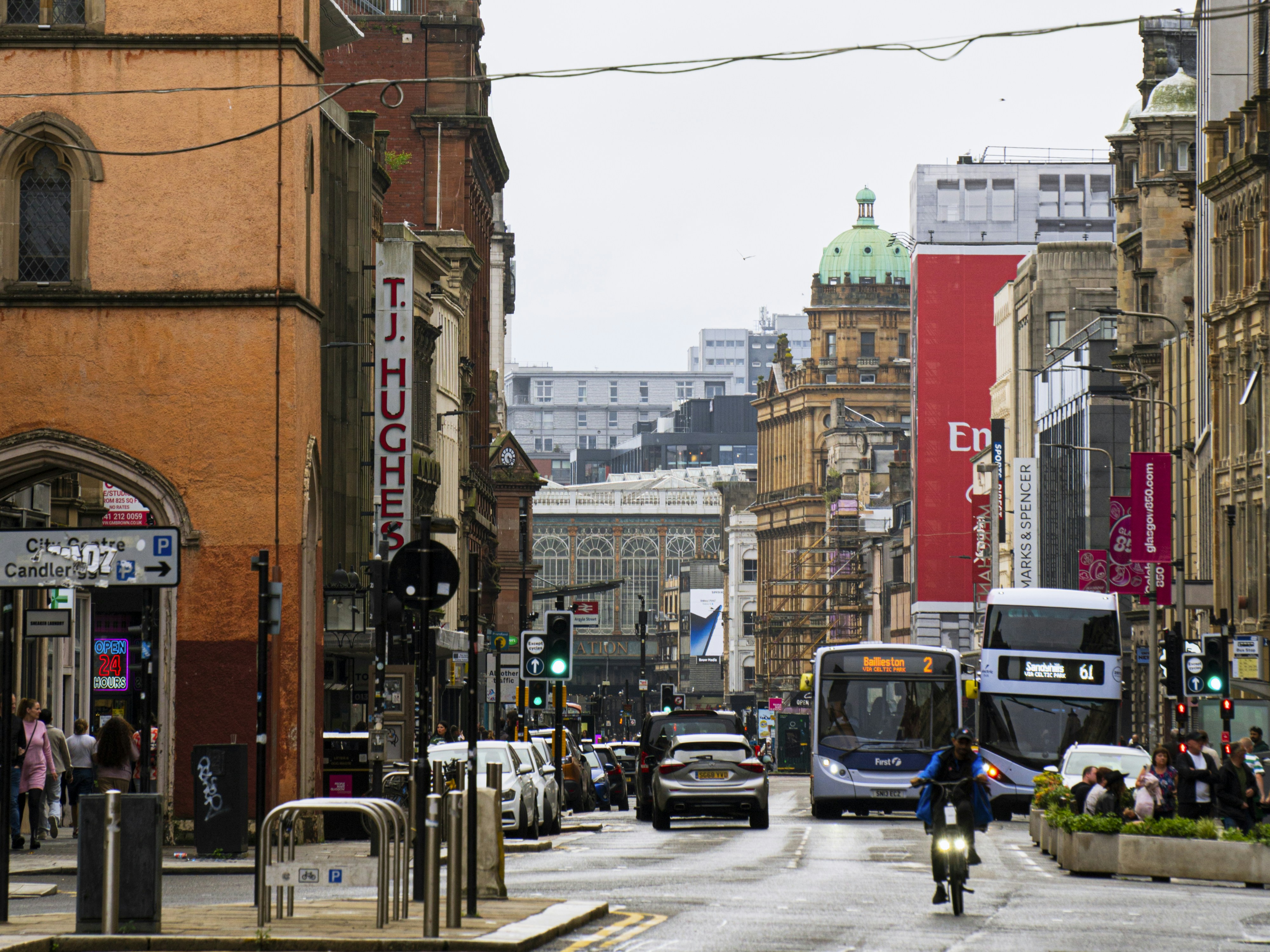 City Pulse: Buses, bikes, and brick facades converge on a sunlit streetscape