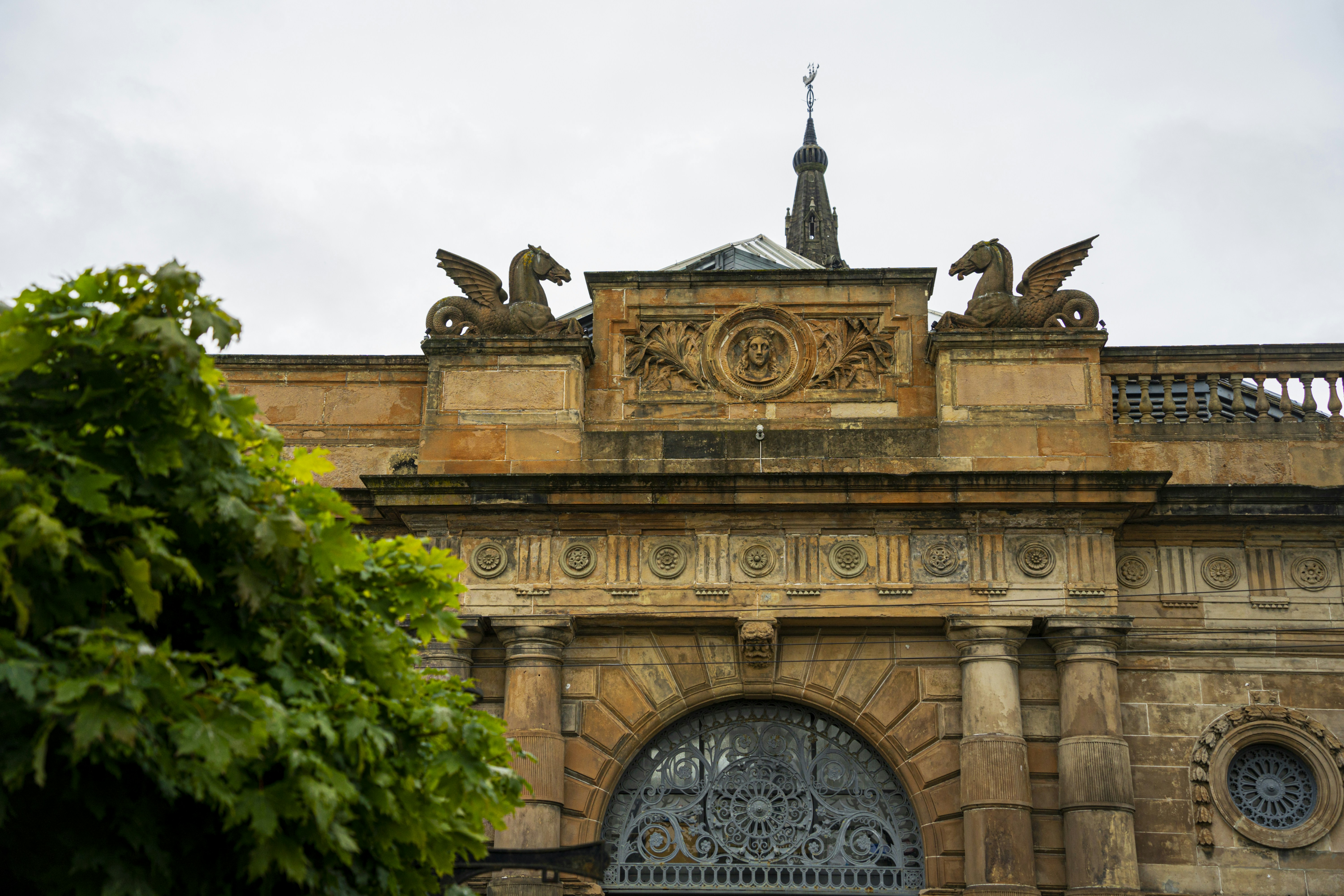 Ornate Archway Sentinel: Eagles and Carvings Above the Gateway