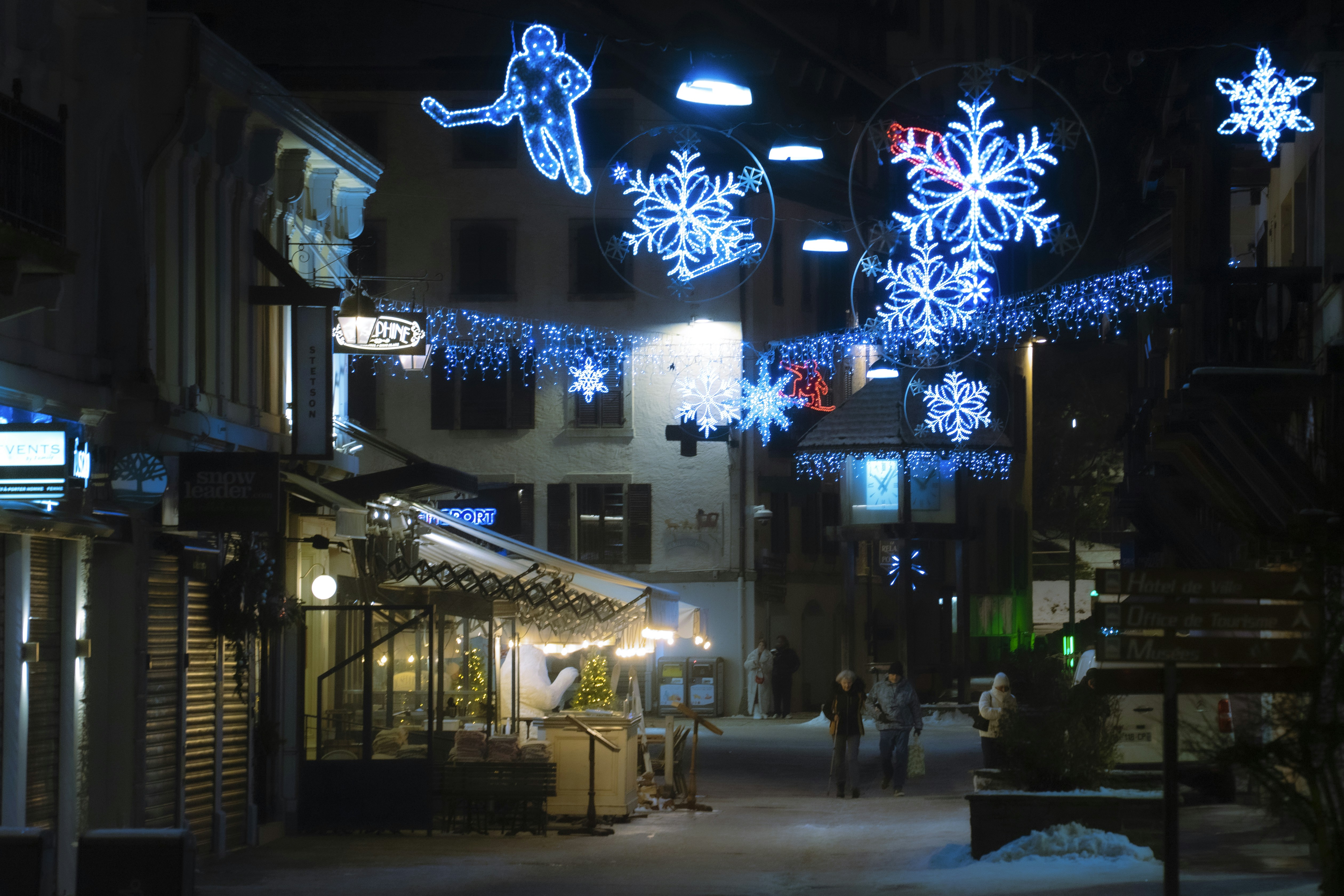 Blue Snowfall Neon: Street Scene Beneath Holiday Lights