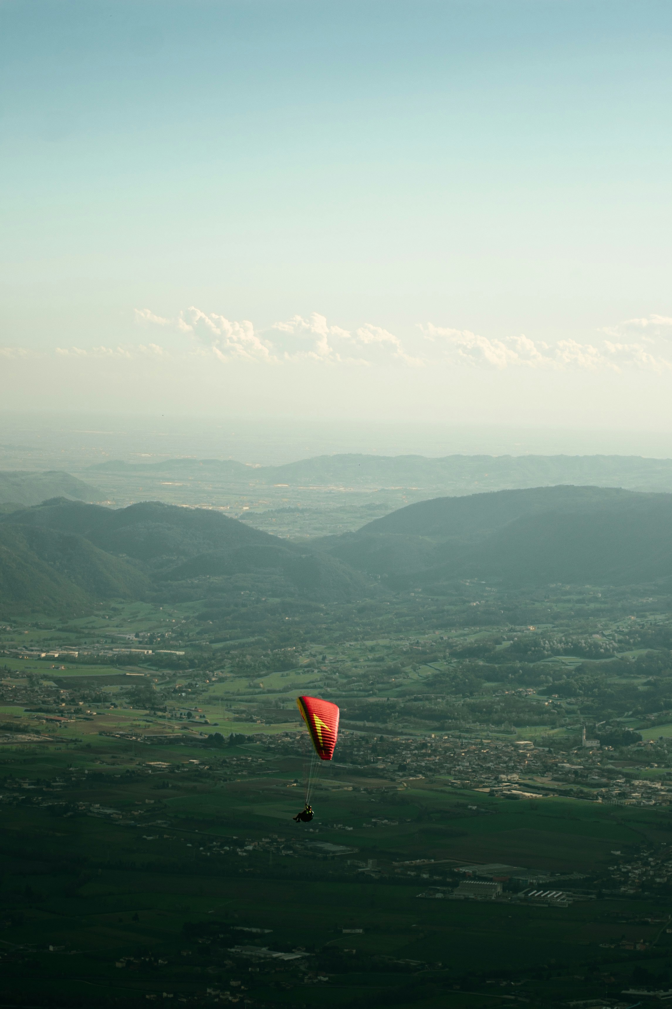 Red Kite Above the Valley: A Solo Glide Over Rolling Hills