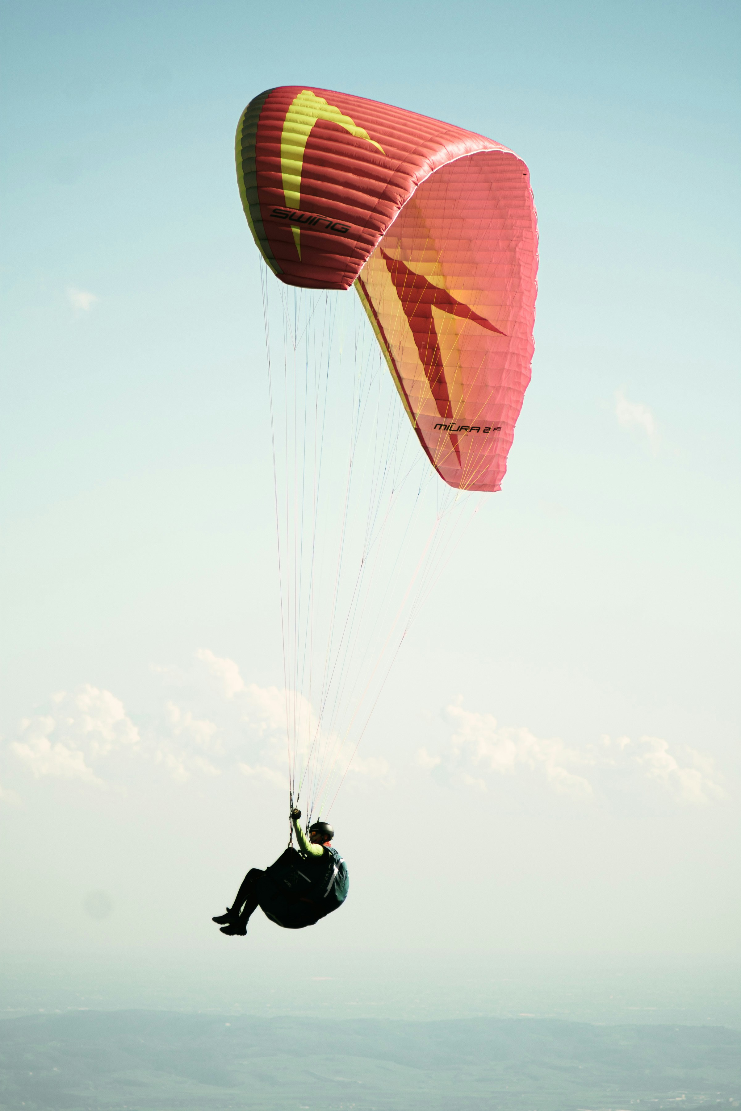 Soaring Silhouette: A Paraglider Traces the Sky