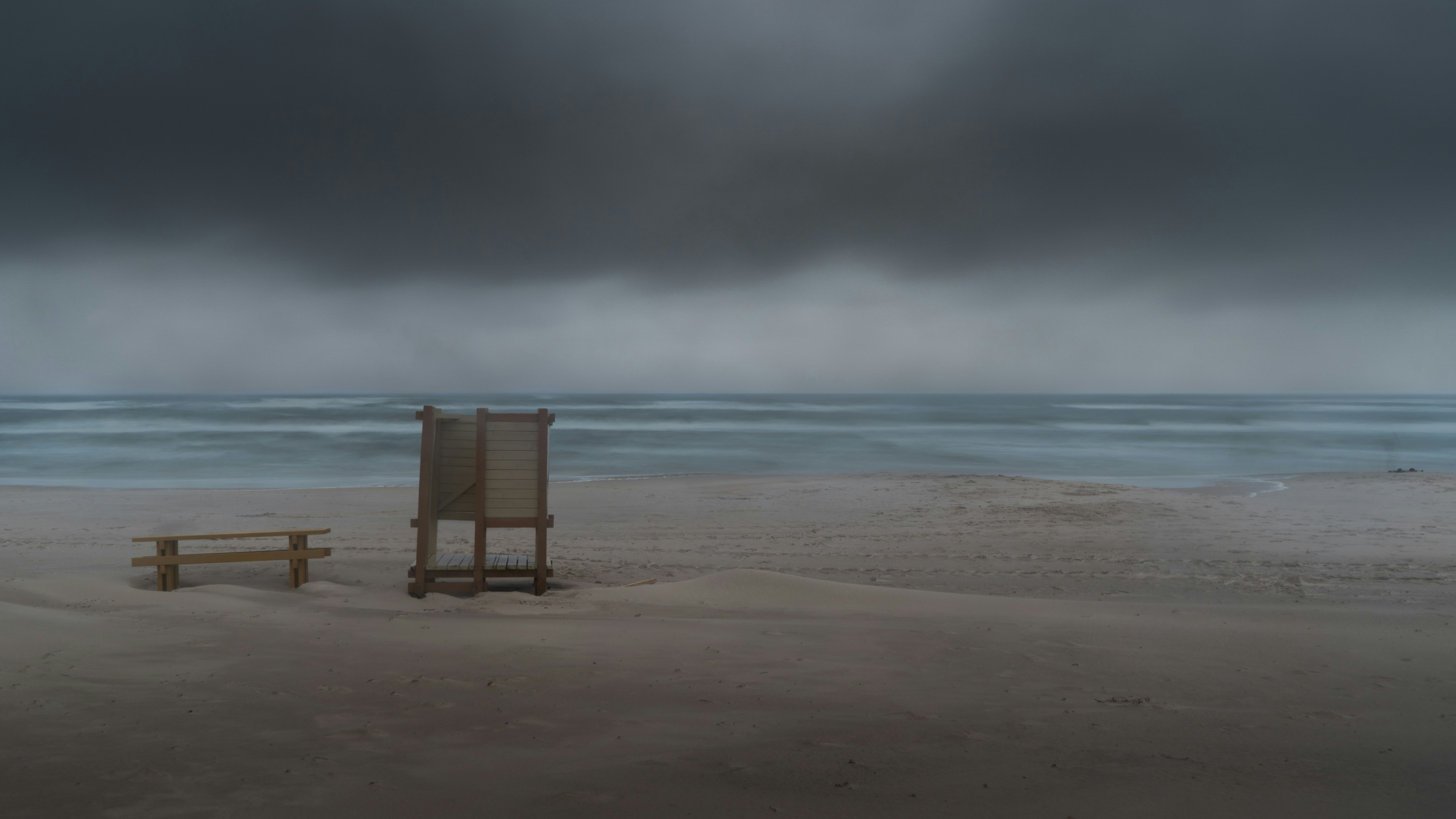 Solitary Beach Furniture Beneath Threatening Skies