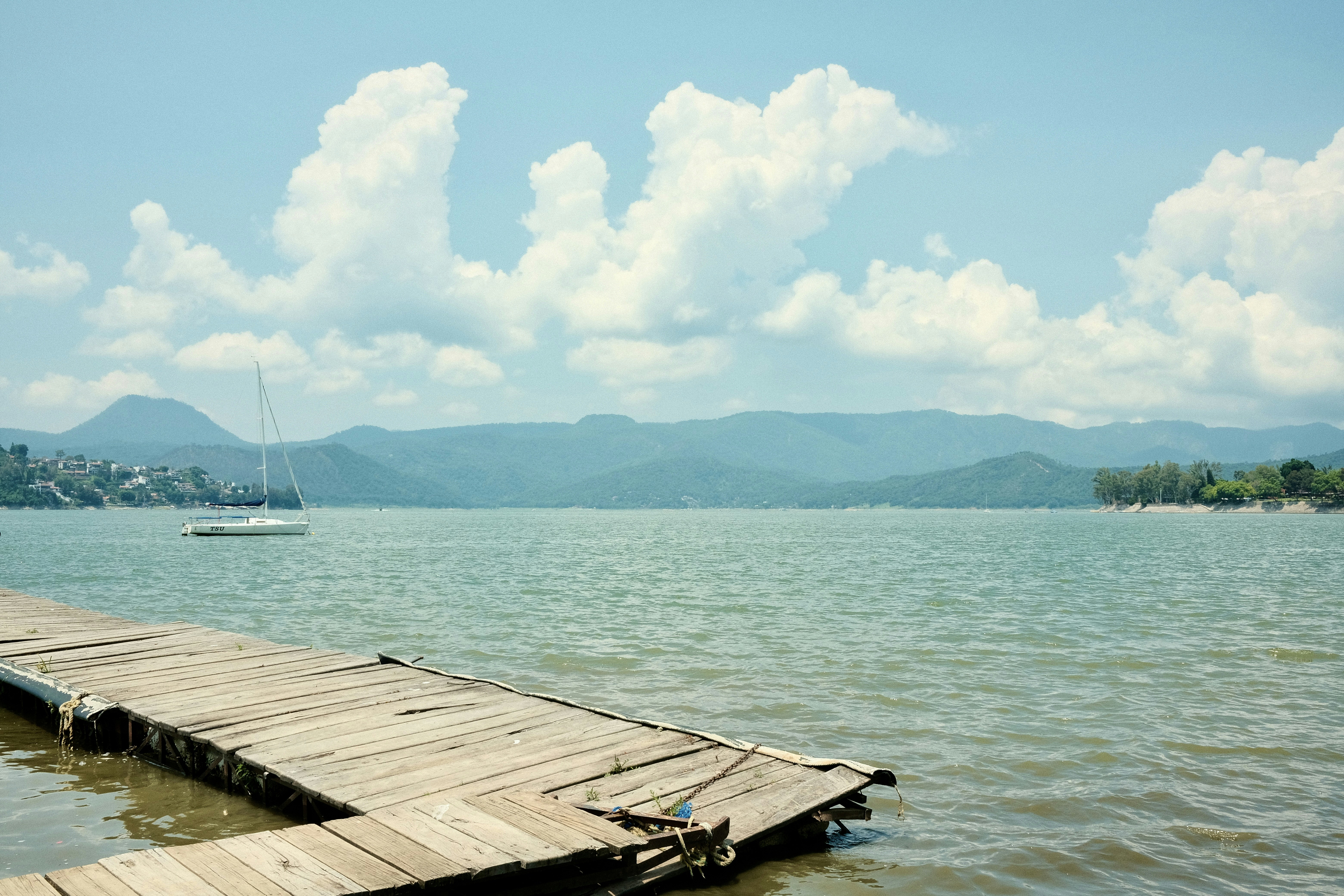 Dockside Calm: A Sailboat at Distant Horizon