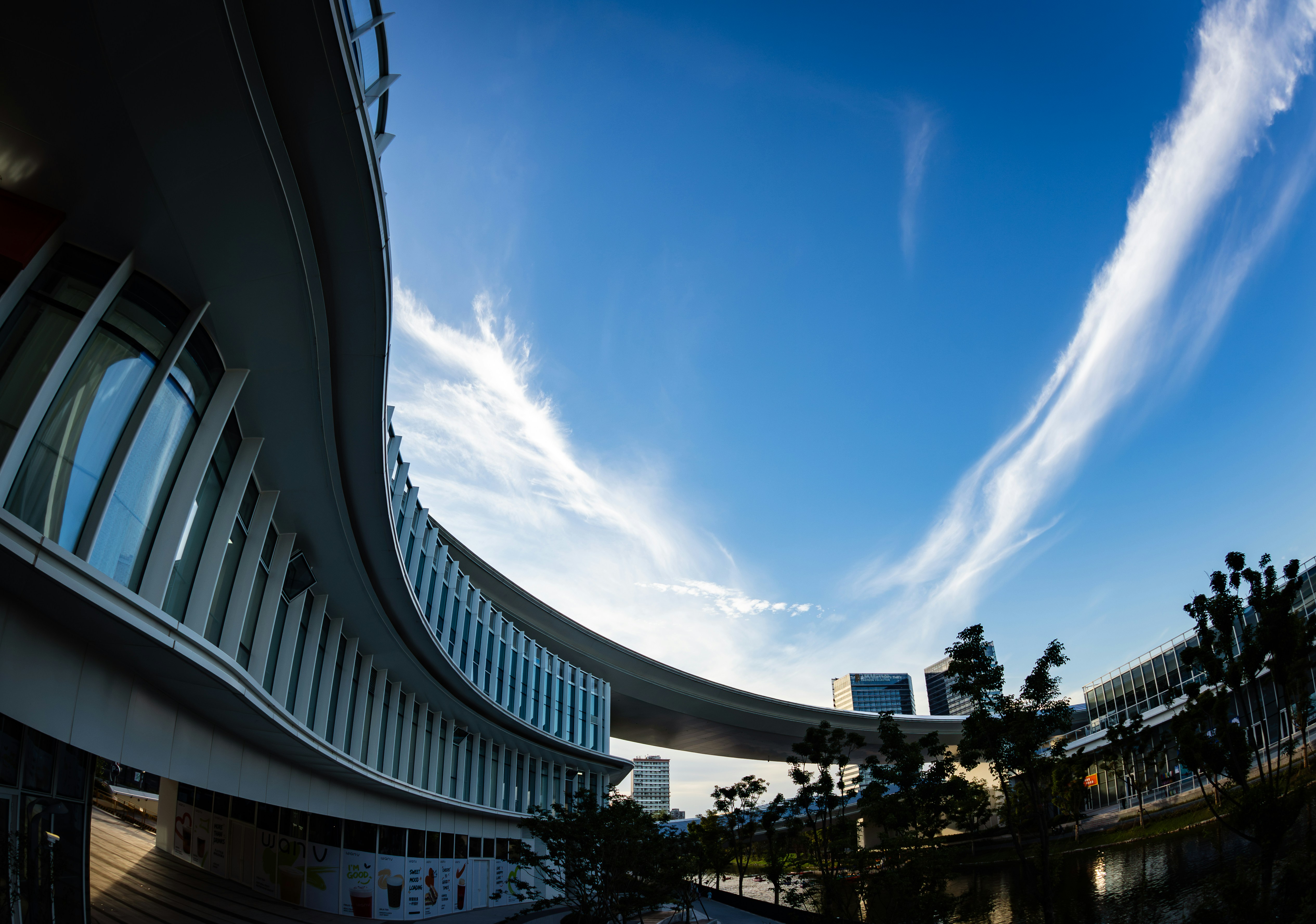 Curved Campus Arcade Under a Cerulean Sky