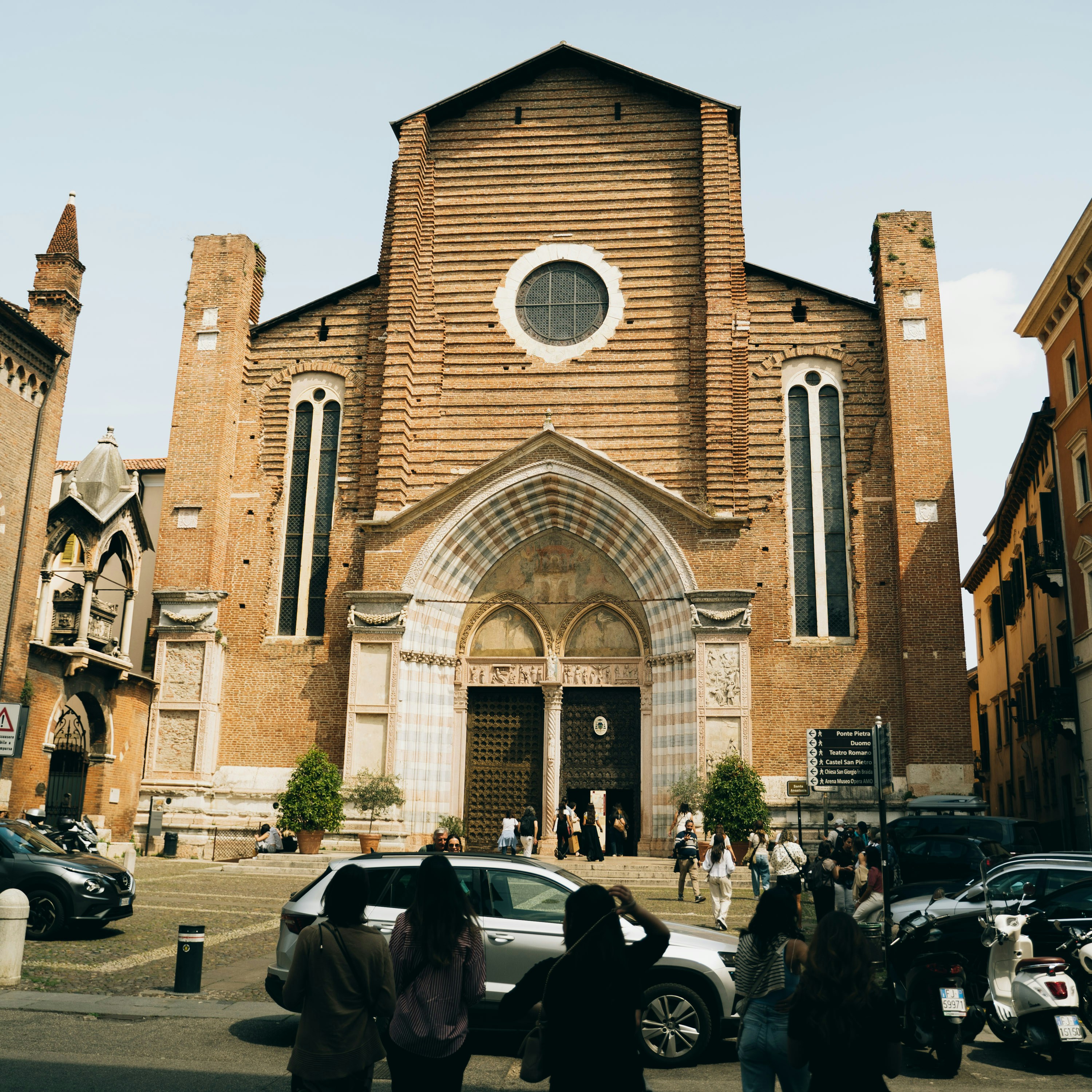 Brick Gothic Portal: People and Car in Front of a Central Church Door