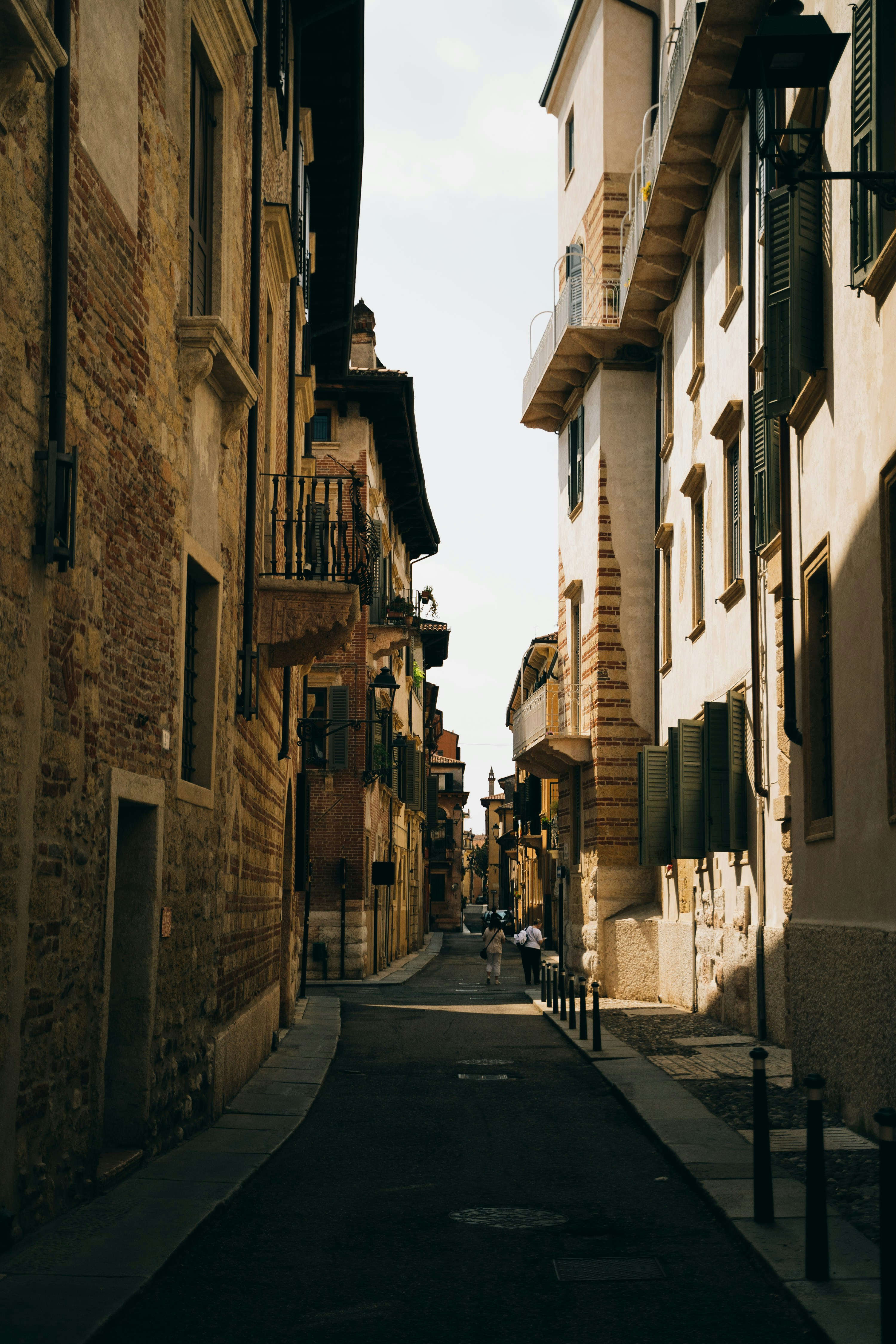 A Narrow Mediterranean Alley Reaching Toward the Bright Sky