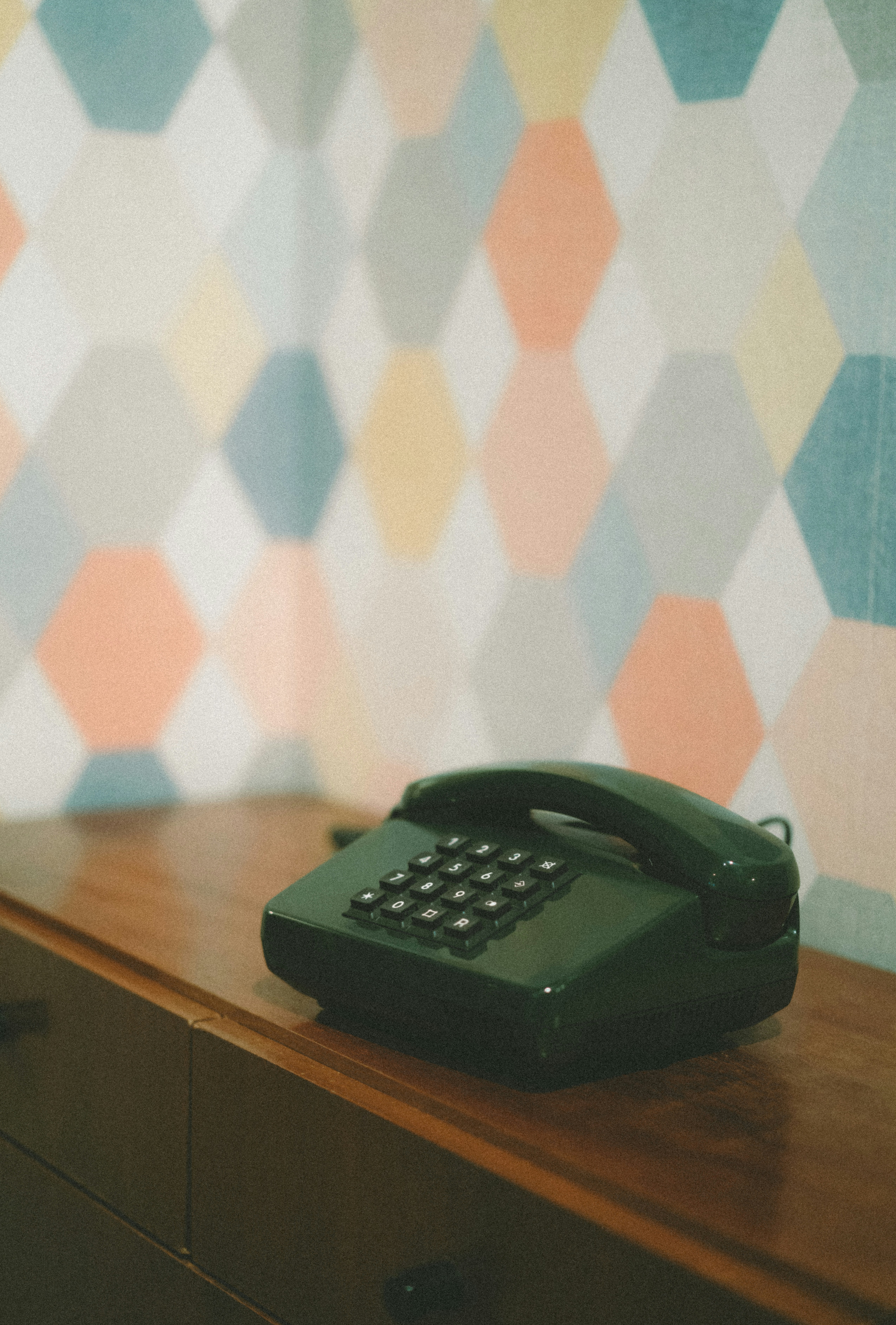 The Quiet Line: A Retro Desk Phone Resting Under Geometric Pastels