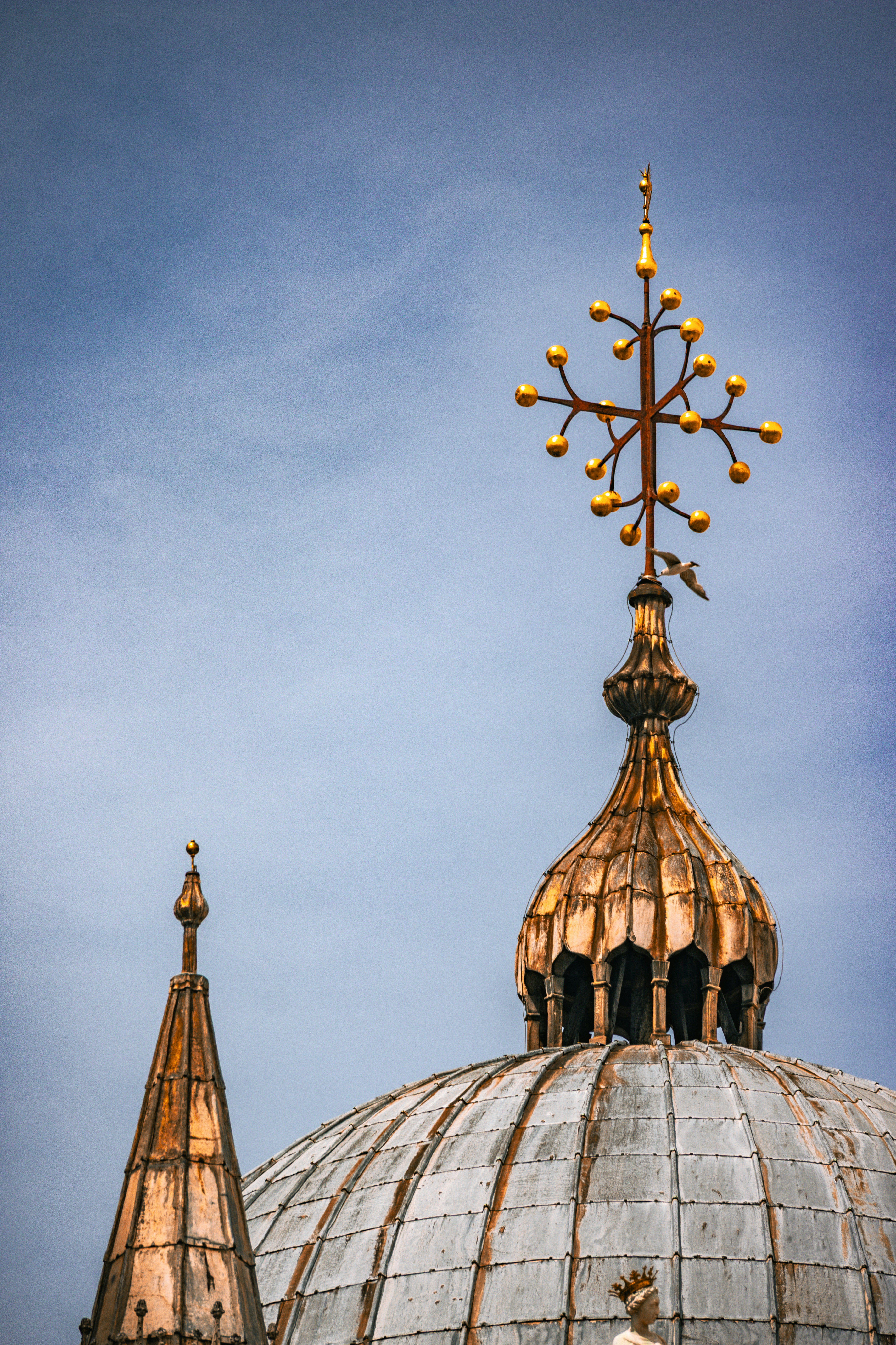Golden Cross over the Dome: a Cathedral Spire Reaches Toward a Pale Sky