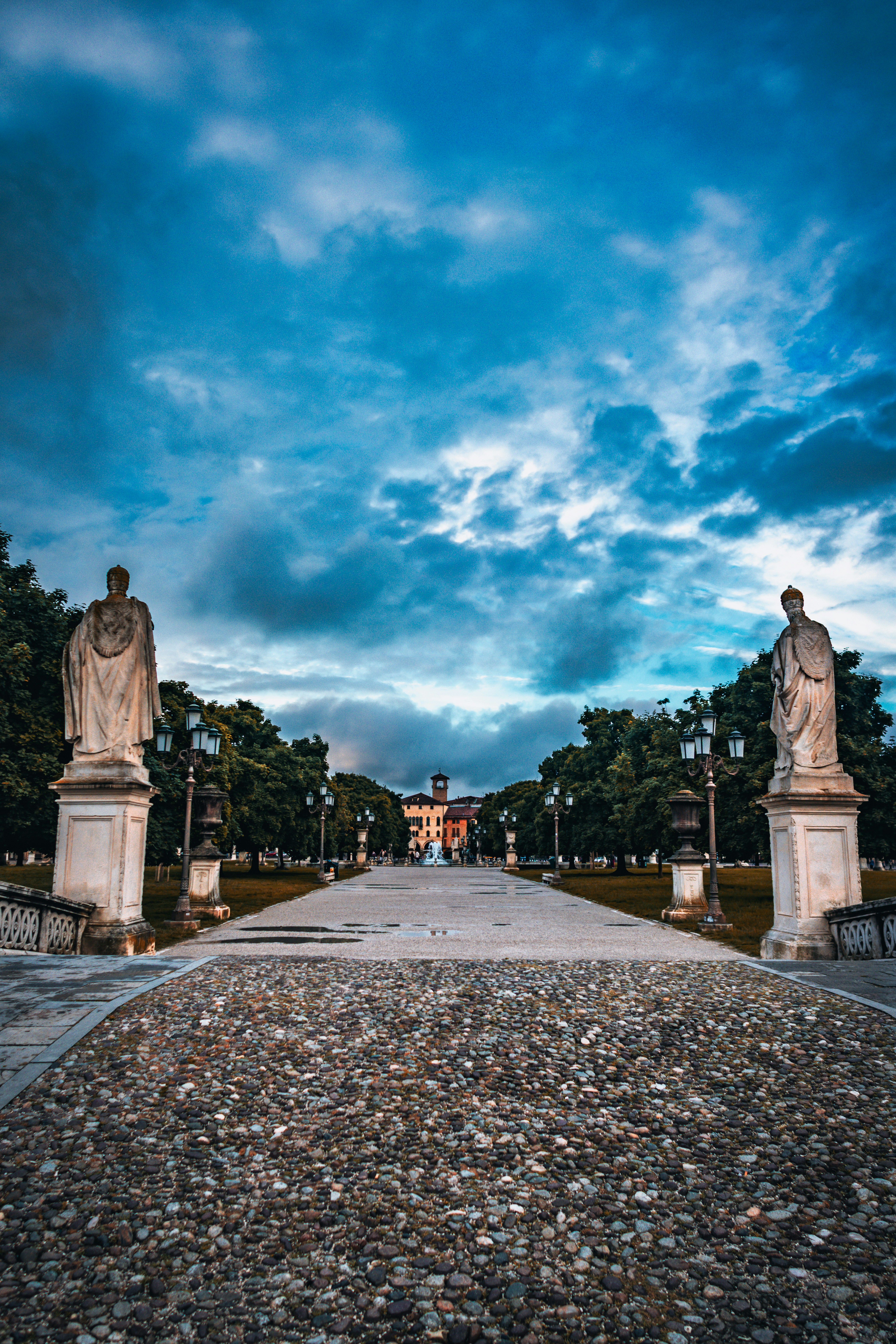 Statues at the Gate: A Wide Avenue Toward the Distant Castle