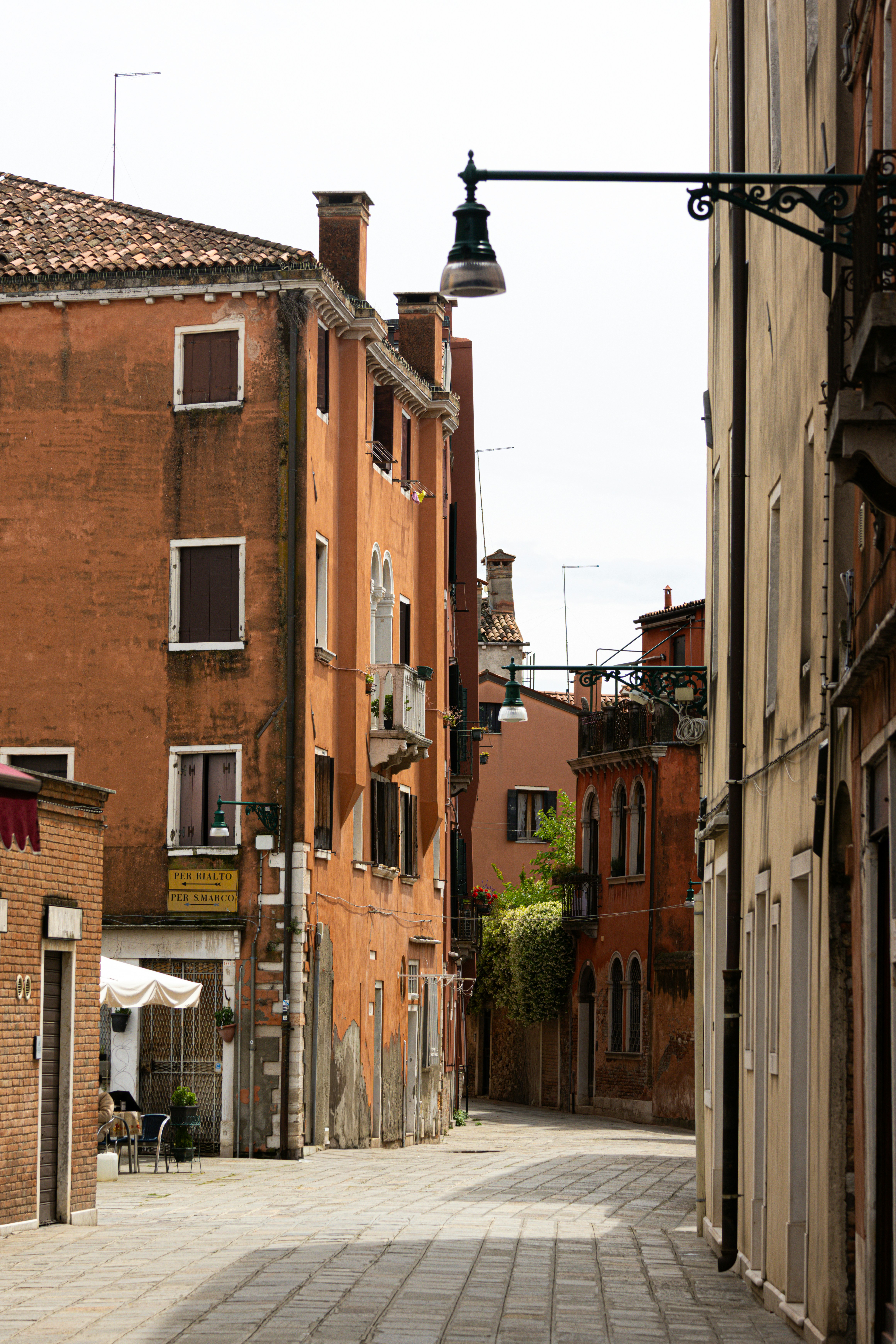 Sunlit Venetian Street: Brick Facades and Quiet Alleyways