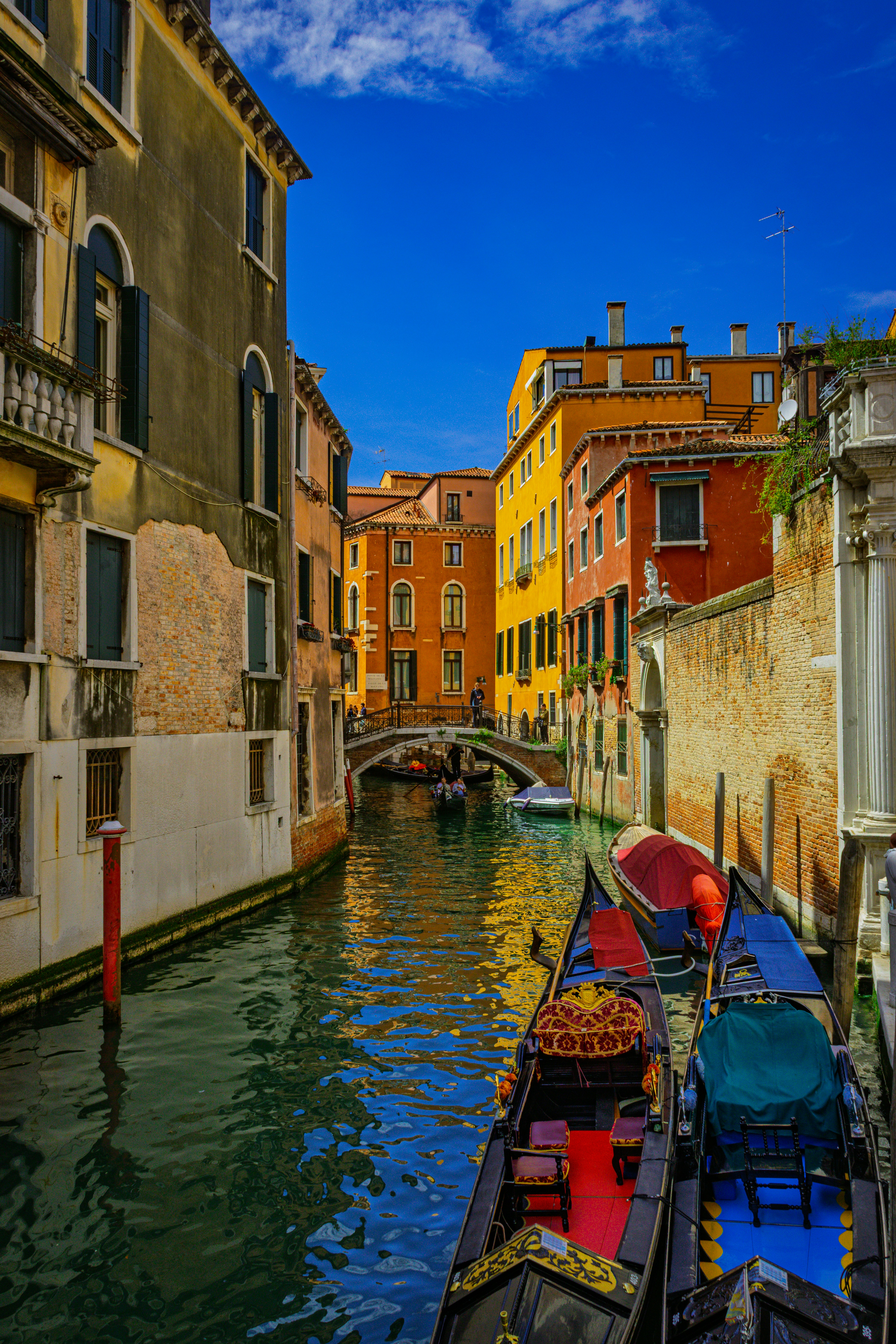 Vivid Canal Corridor of Venice: Colorful Facades Reflected in Quiet Waters